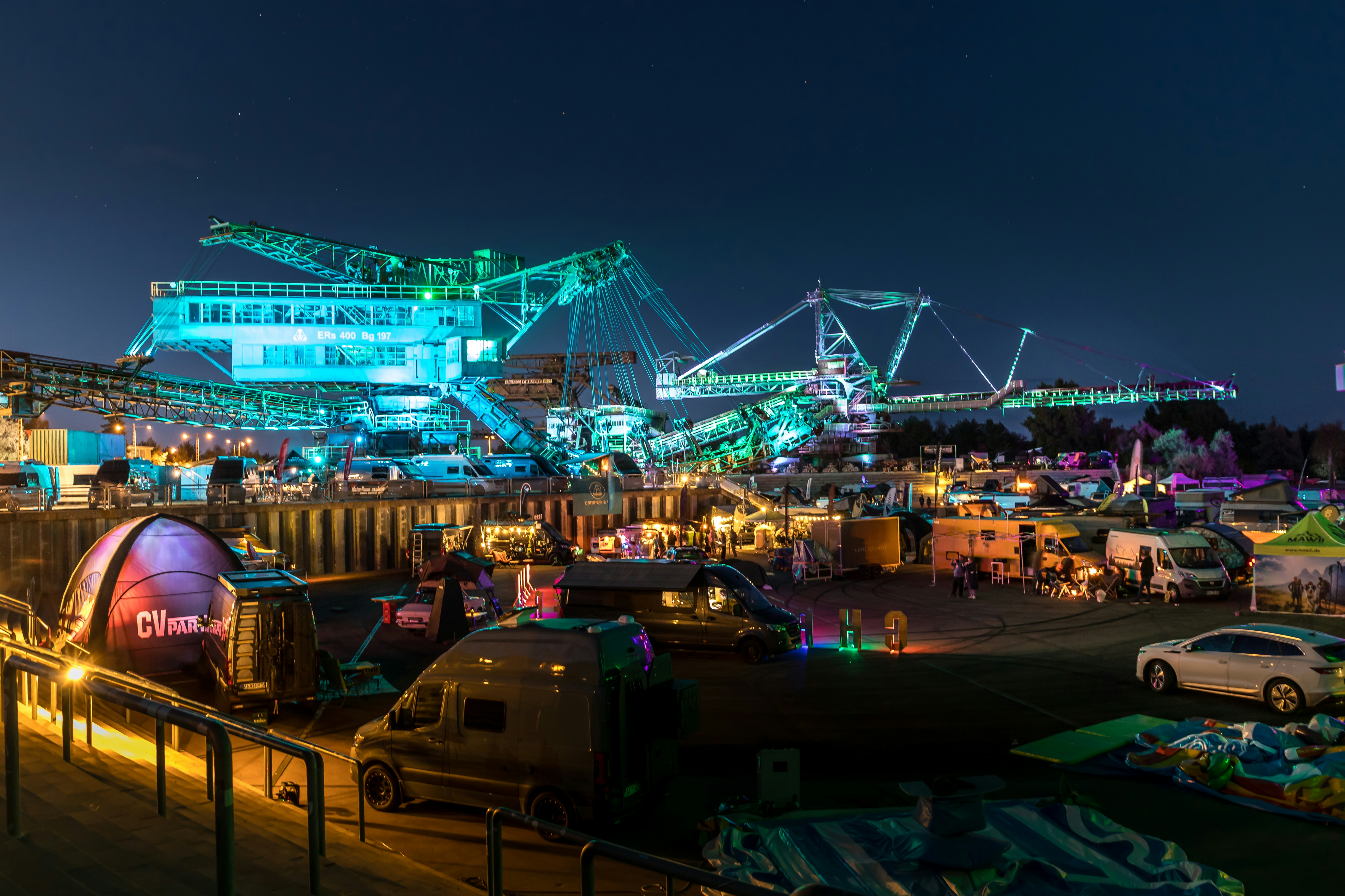 Industrial Nightscape: Neon-lit Cranes Over a Busy Shoreline Event