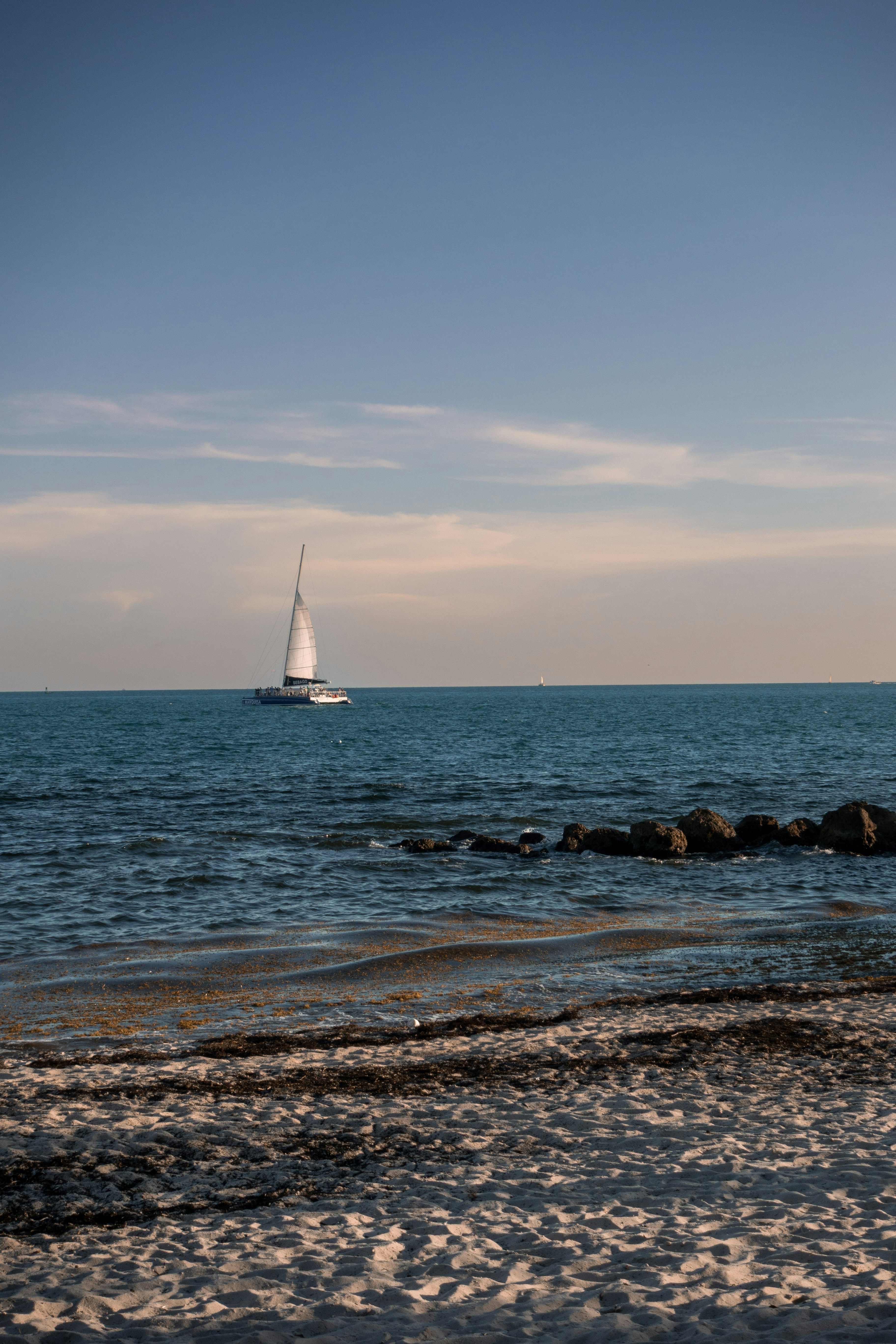 Sailboat on a Calm Sea at Dusk