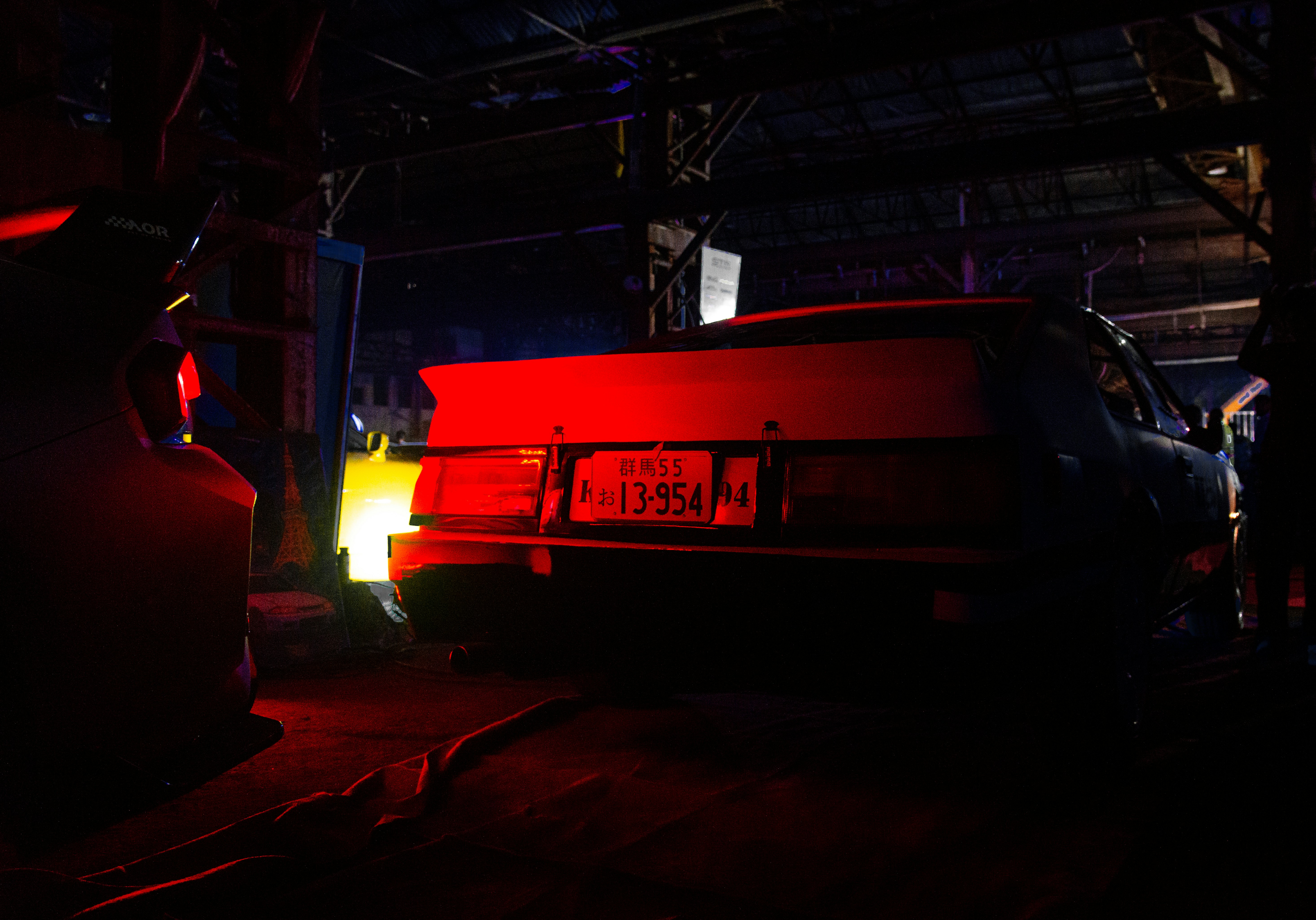 Red-Eyed Bunker Drift: A Dimly Lit Car Garage Scene