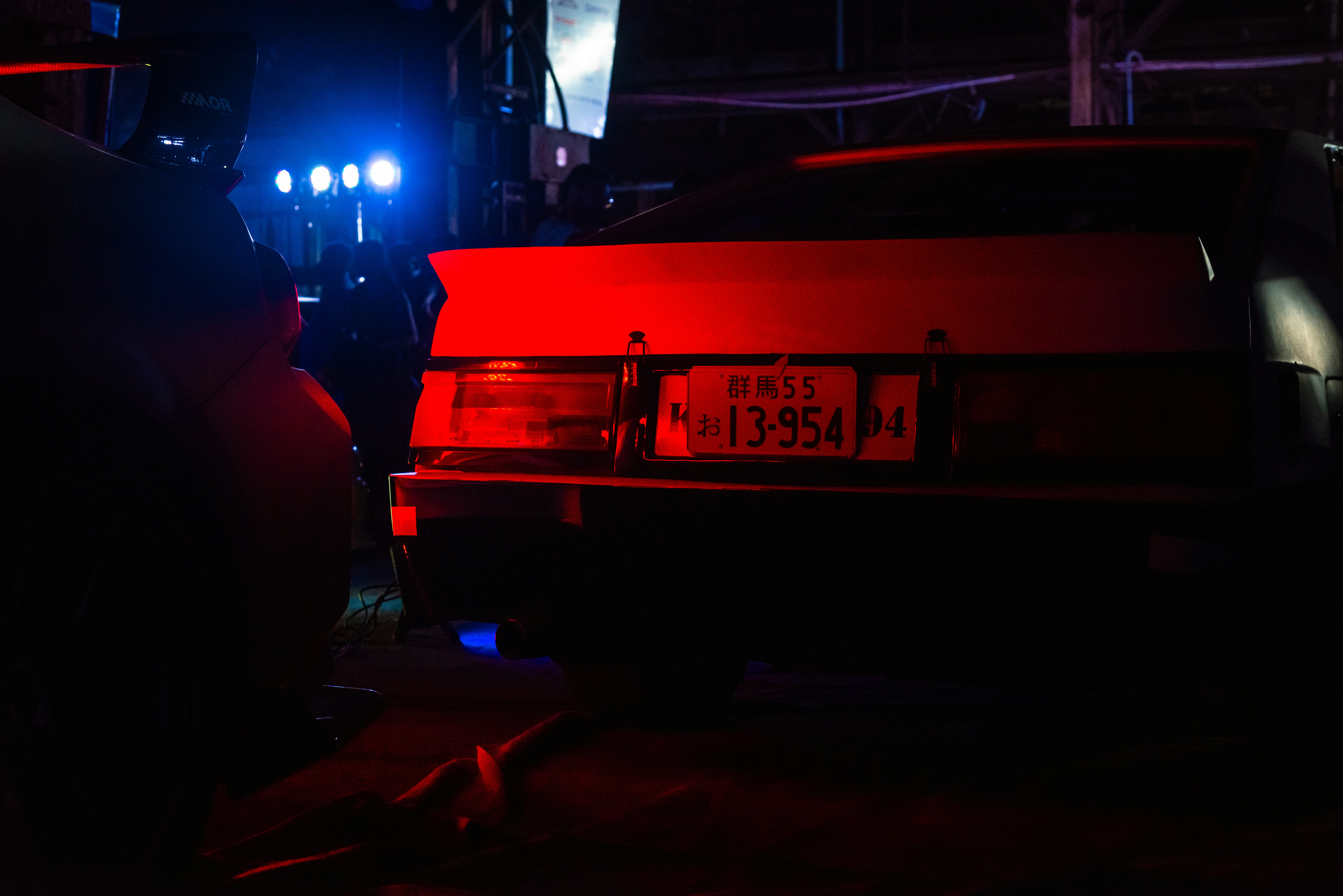 Red Car in a Night Scene Under Neon Blues
