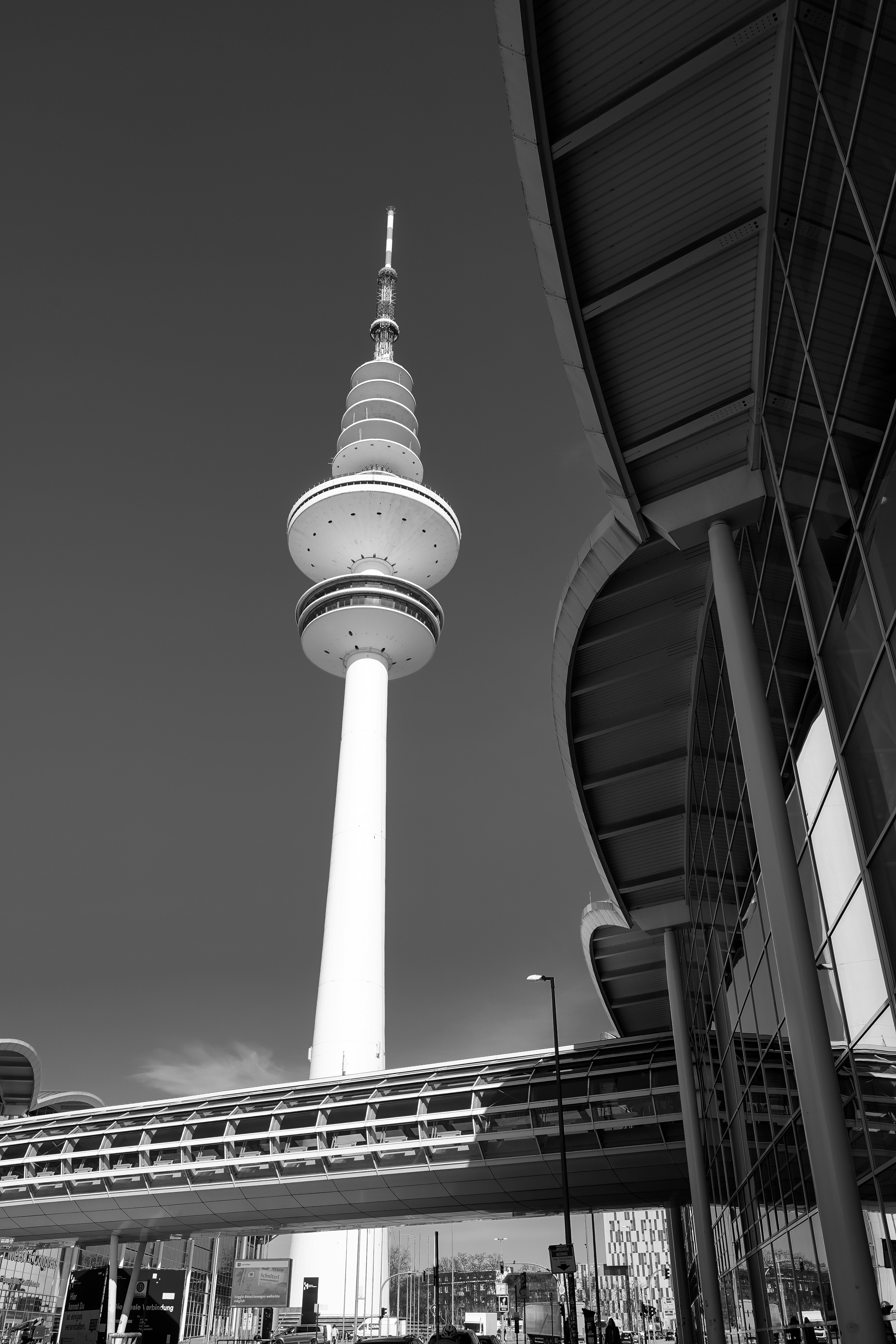 Shadowed Skyline: The Fernsehturm Rises beside a Modern Arc