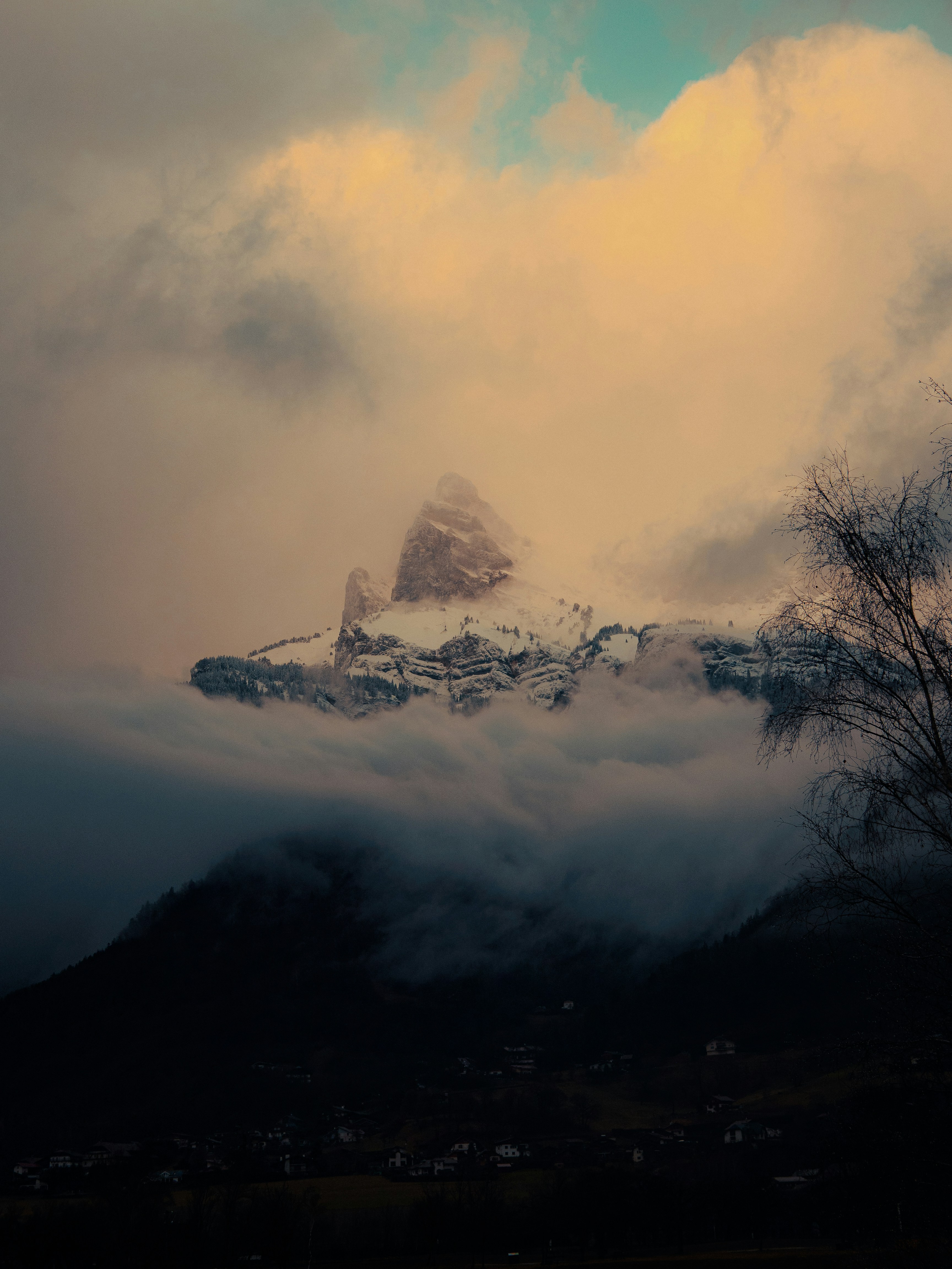Cloud-kissed Peak Emerging from a Veil of Mist