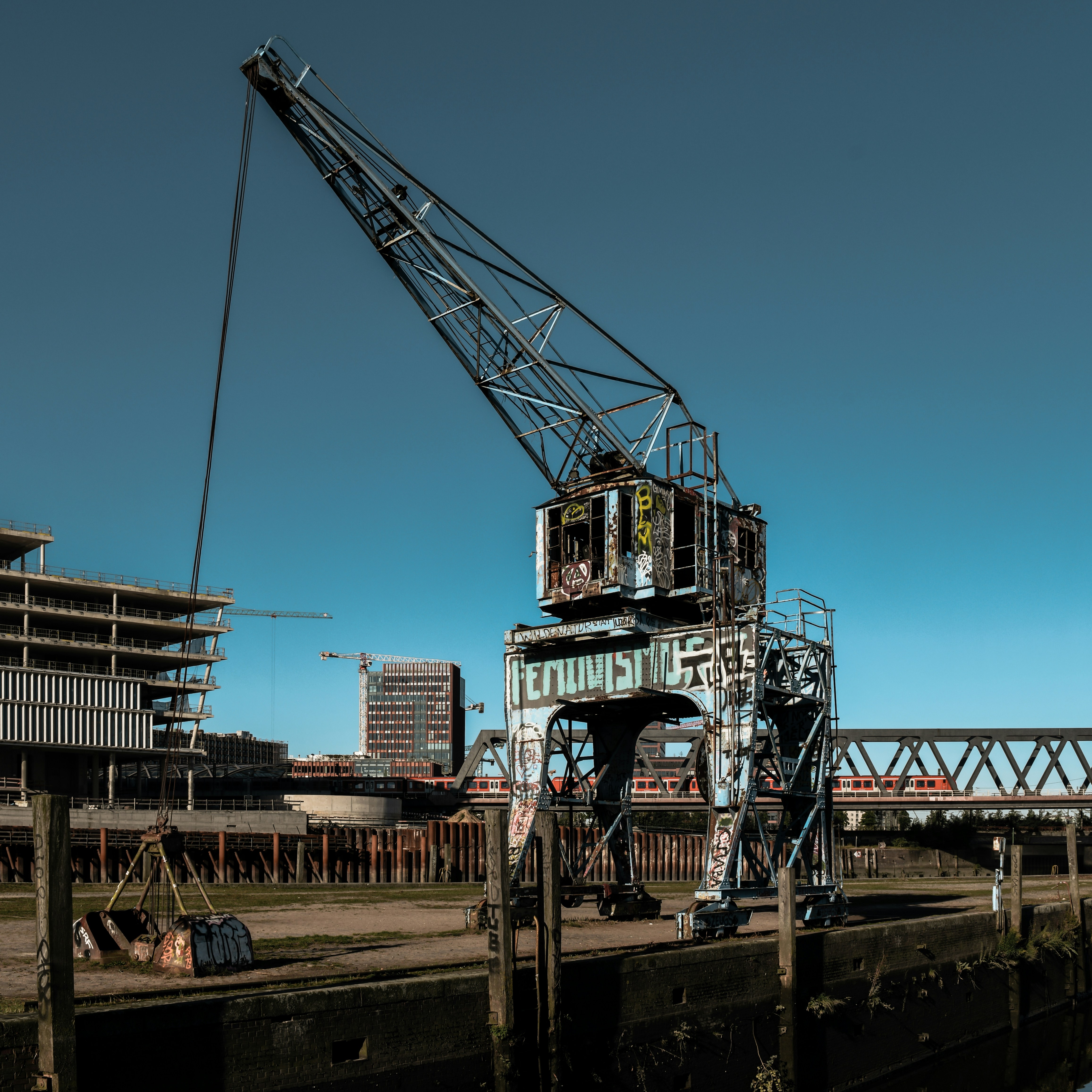 Industrial Crane Sentinel Over a Rusted Pier