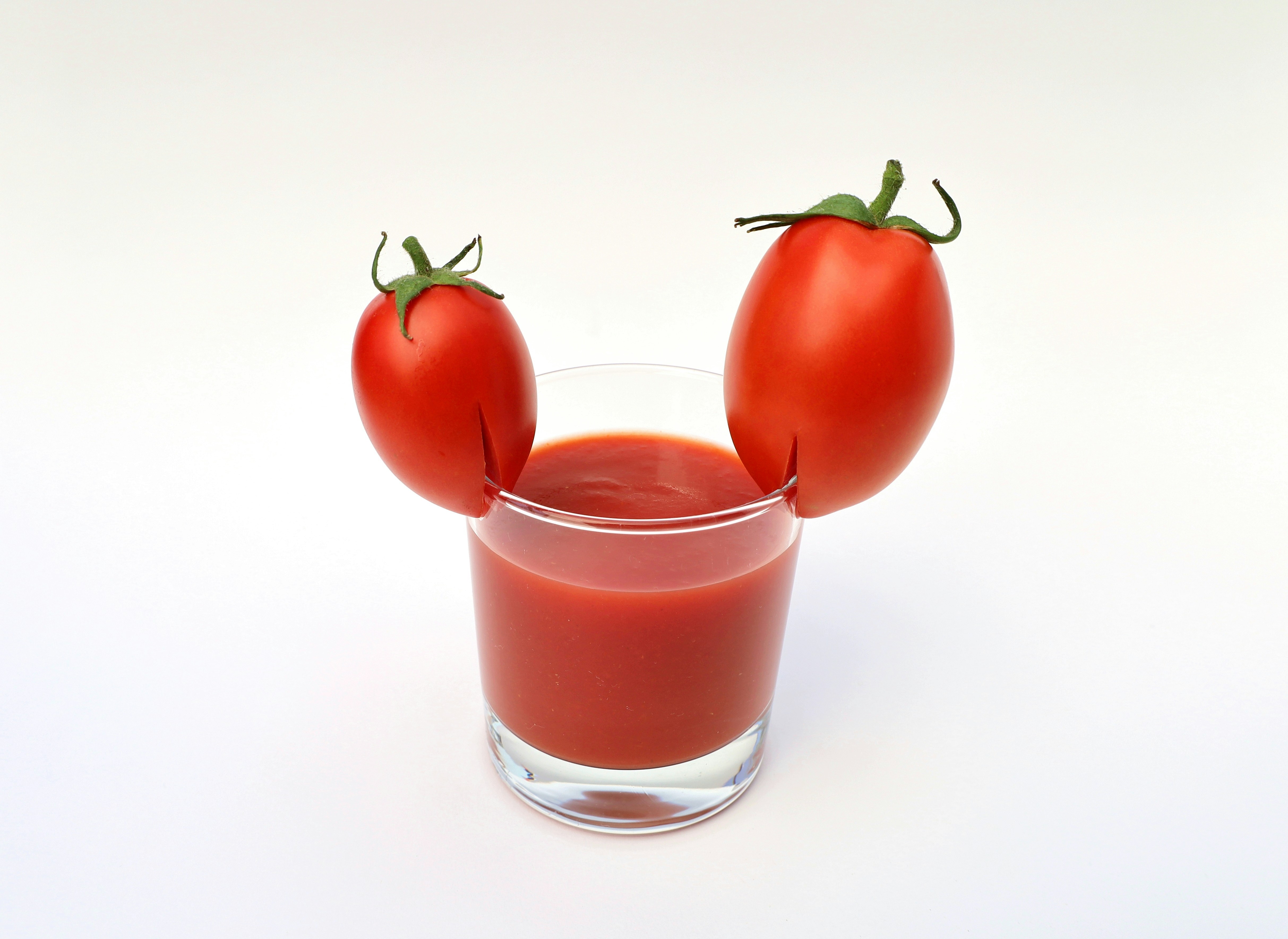Two Tomatoes Take Center Cup: A Minimalist Splash of Tomato Juice