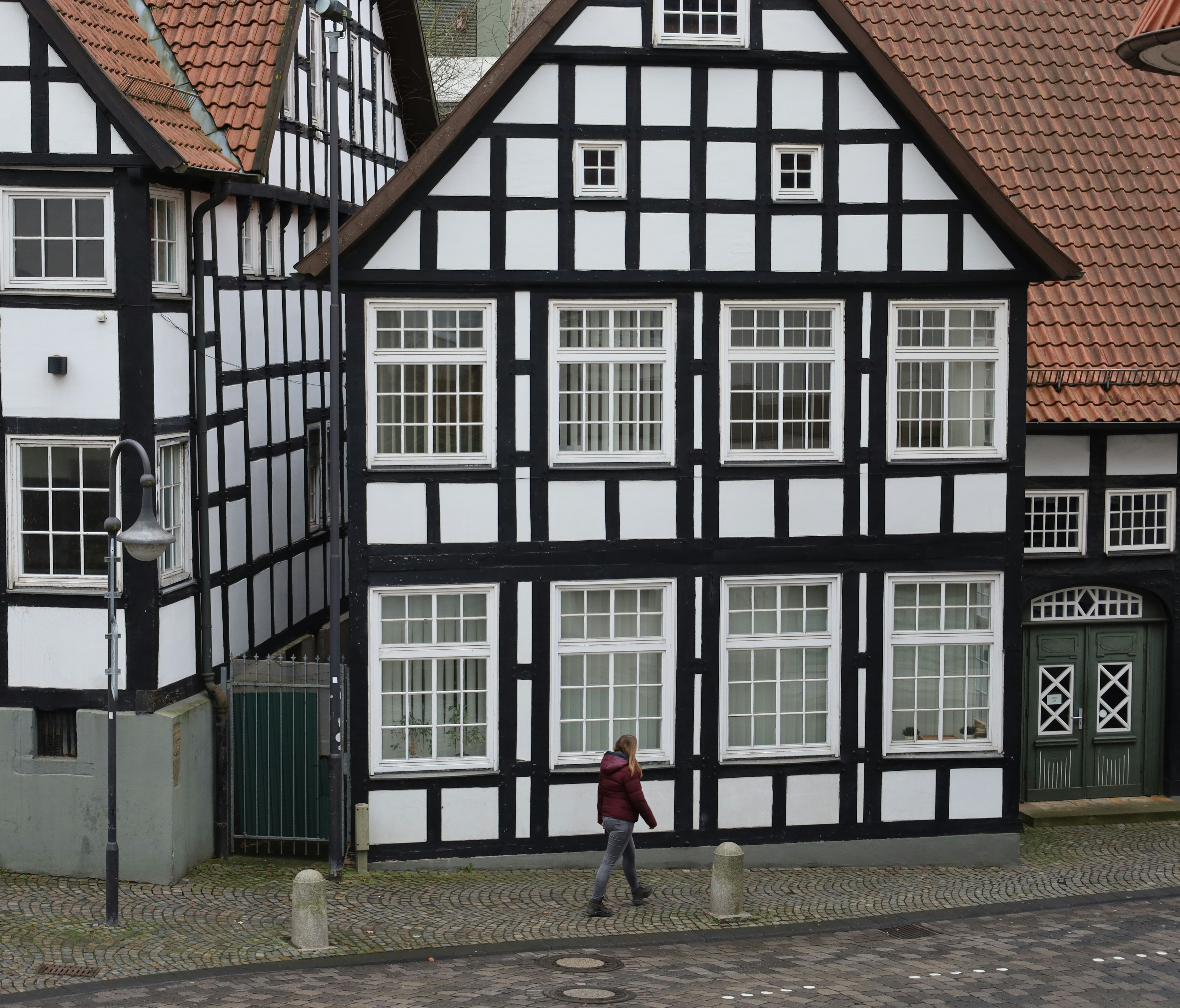 Timber-Framed Facade and a Striding Figure