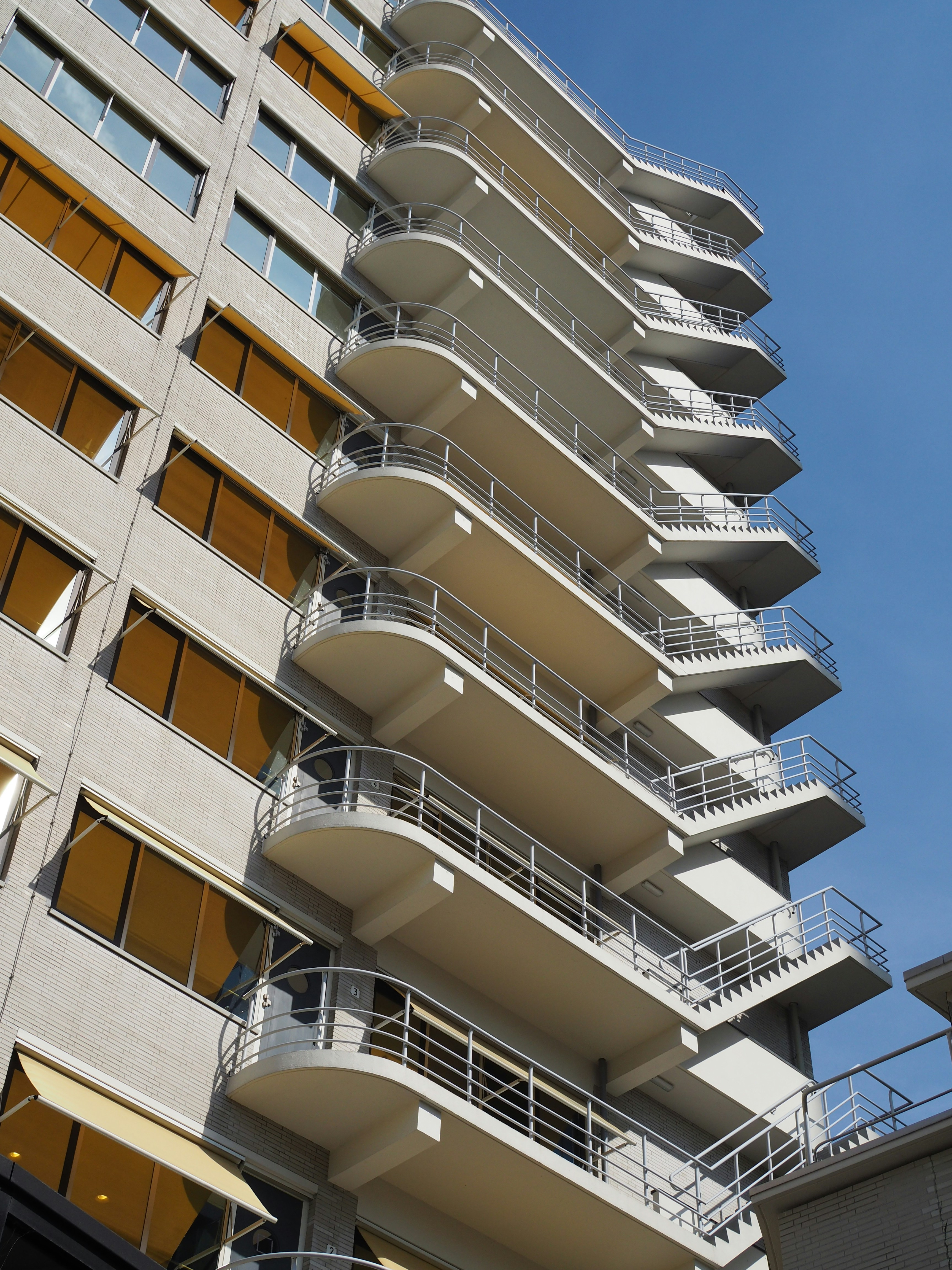 Vertical Rhythm: A Tower of Balconies Against a Clear Sky