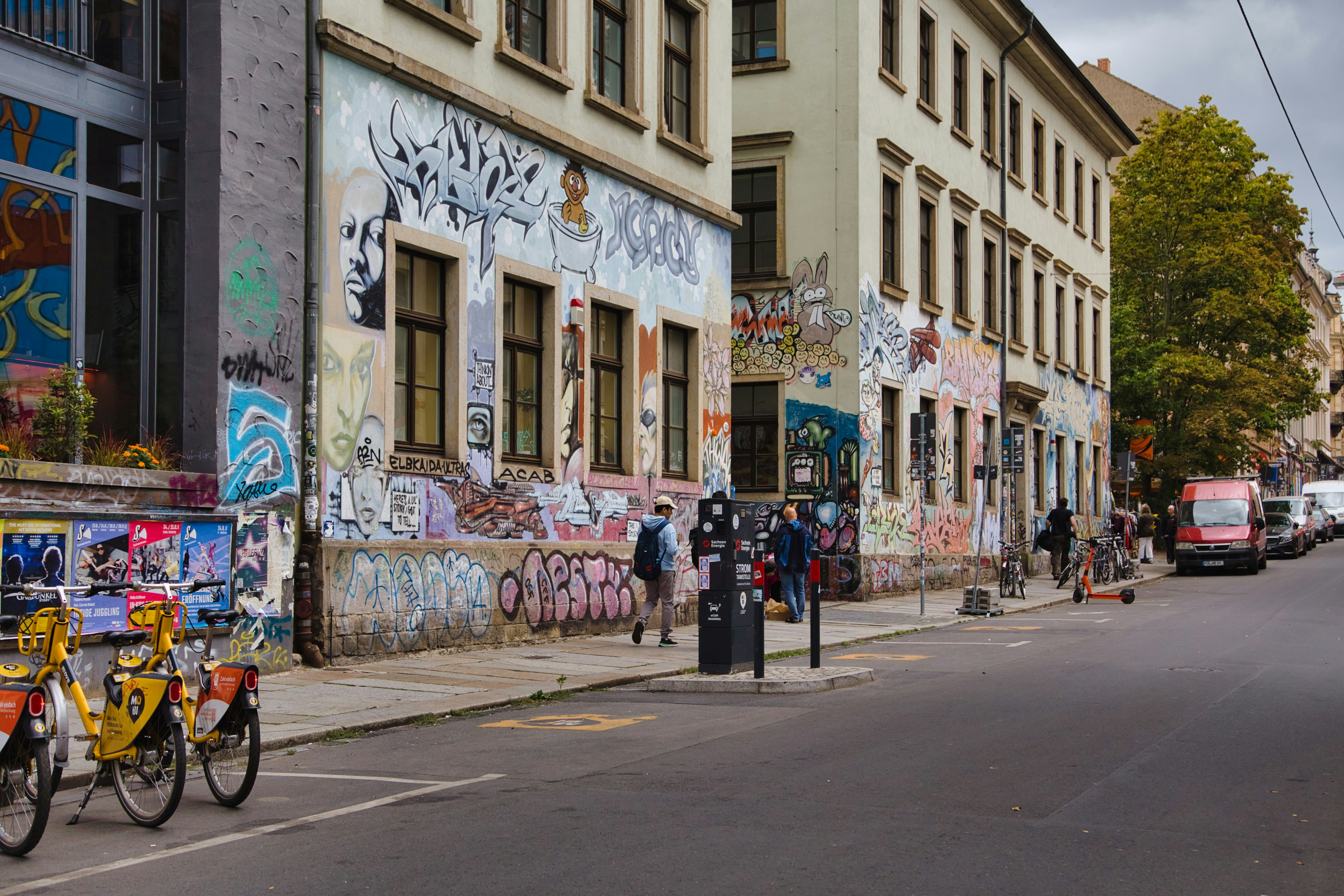 Graffiti-lined Street Amidst Urban Rhythm