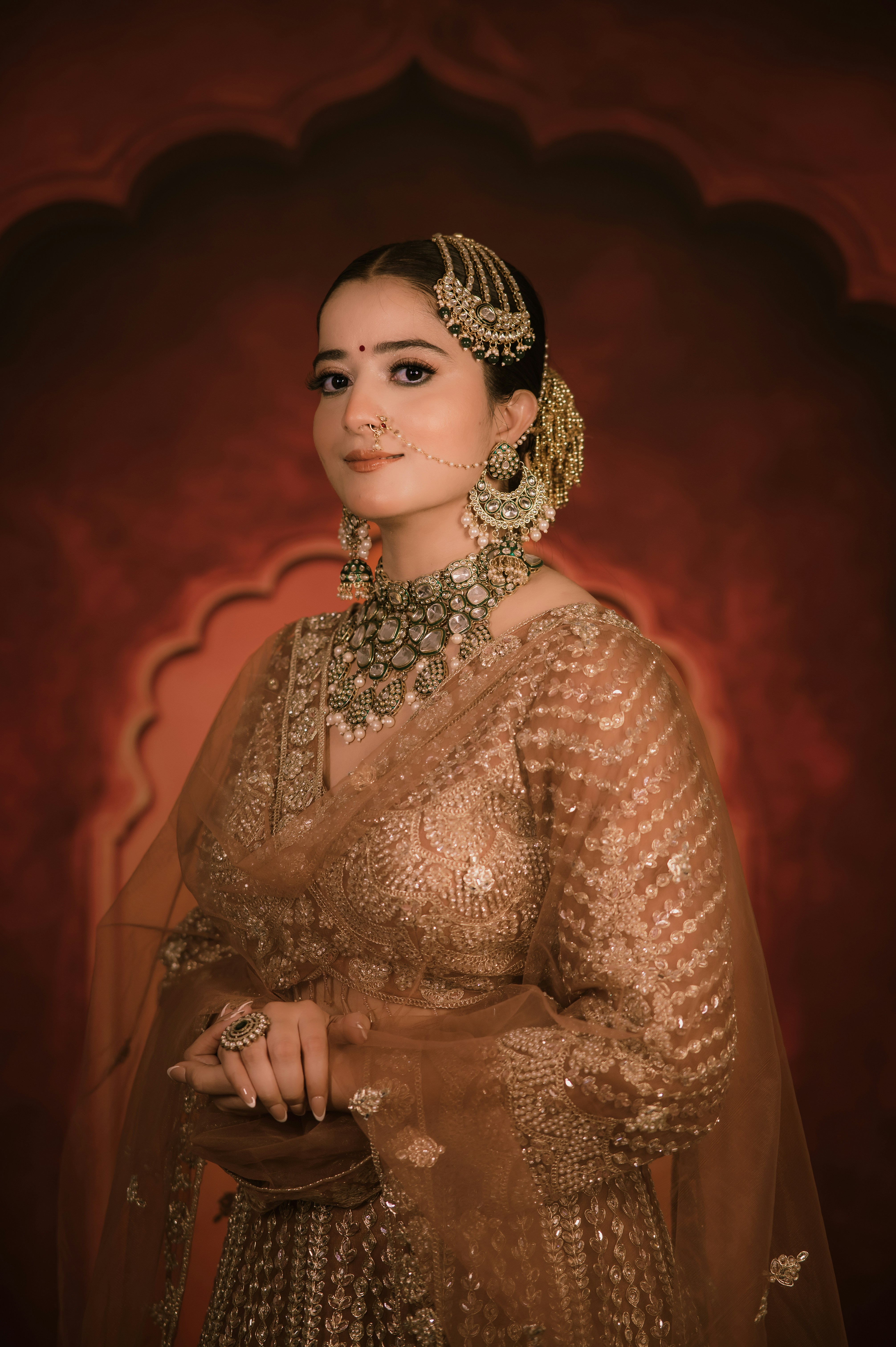 Regal bridal poise beneath ornate jewelry