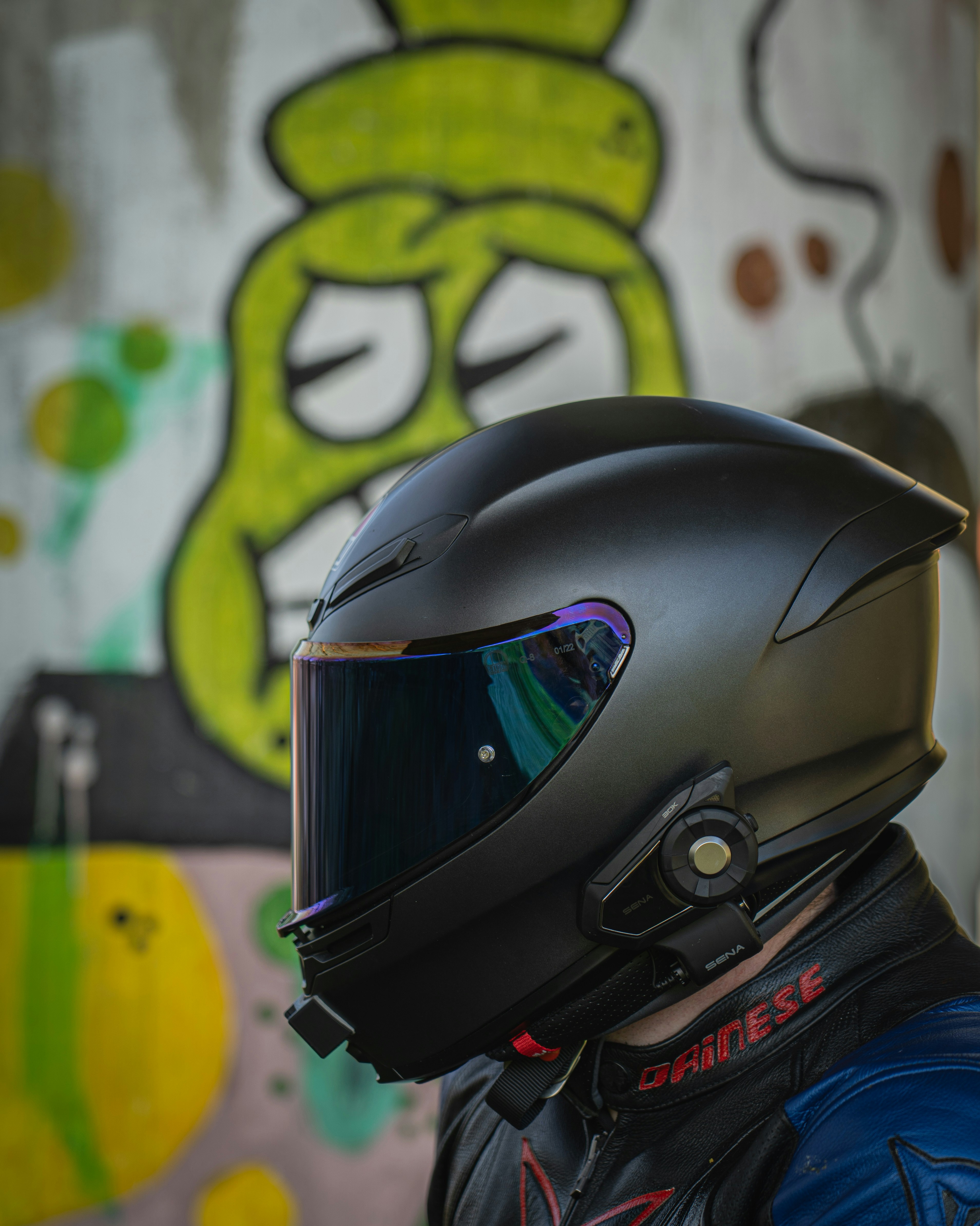 Matte Helmeted Rider Against Graffiti Backdrop