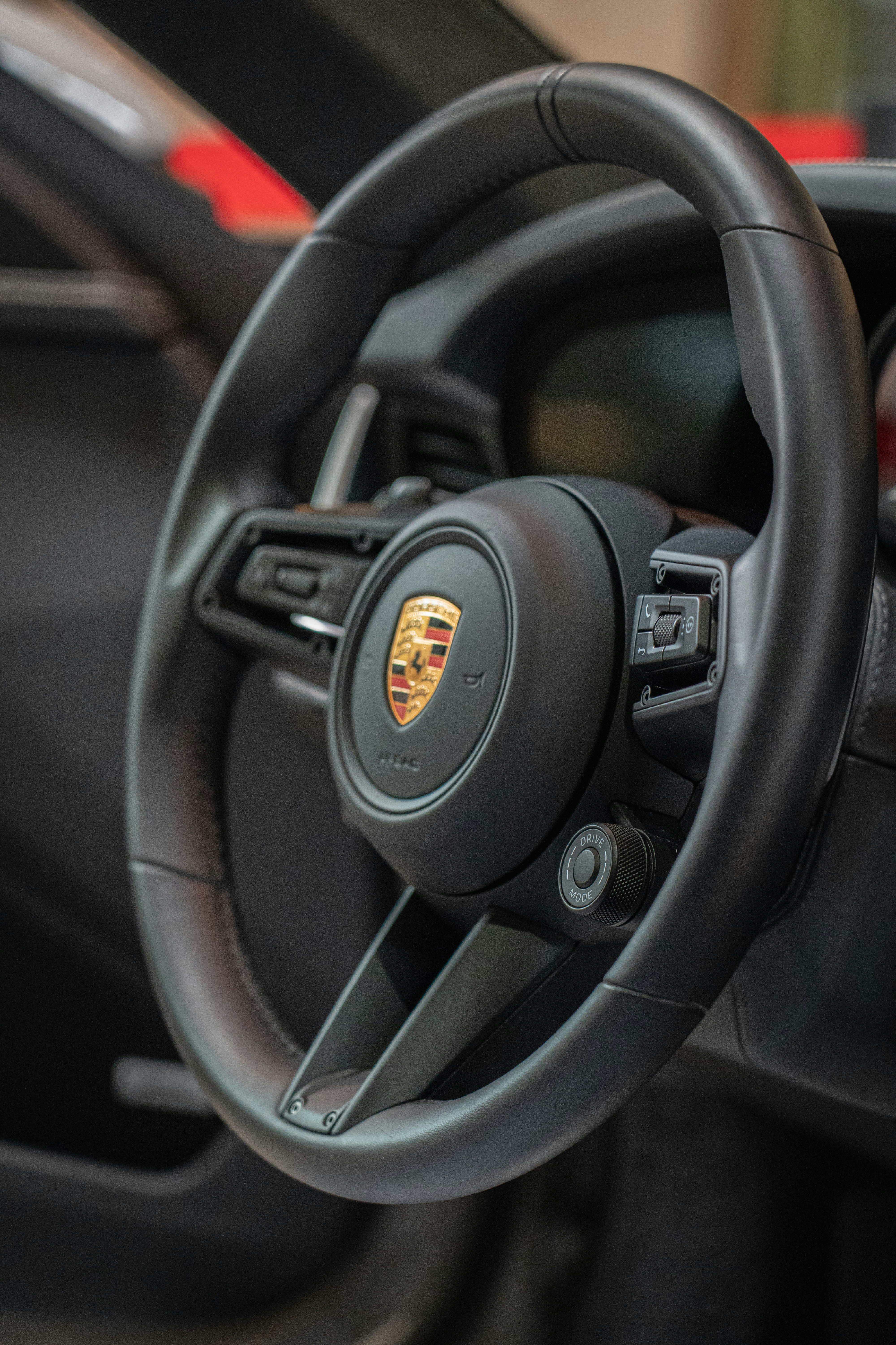 Steering Passion: Porsche emblem framed by a racing cockpit