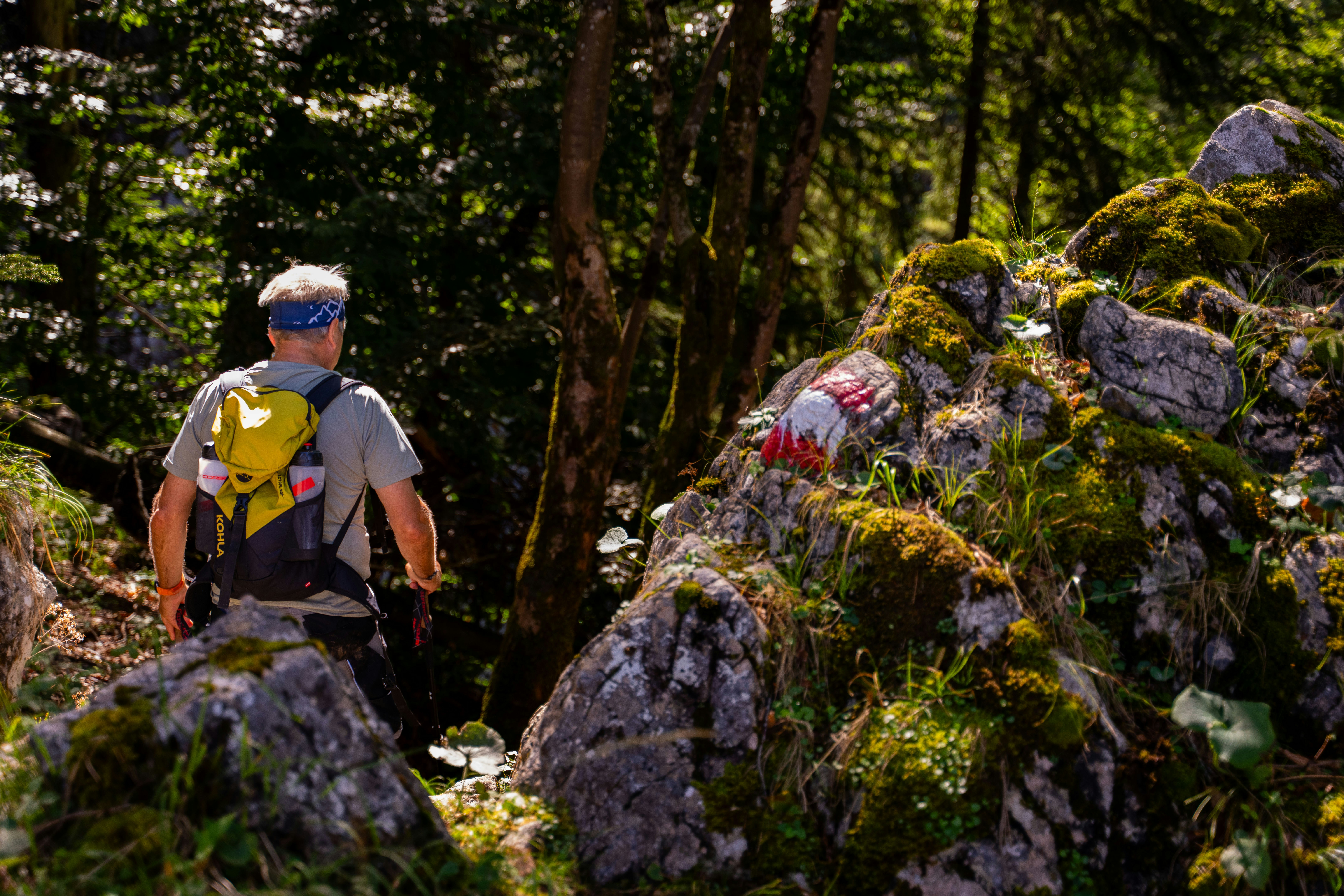 Trailbound: A Hiker Navigates Mossy Rock Terrain