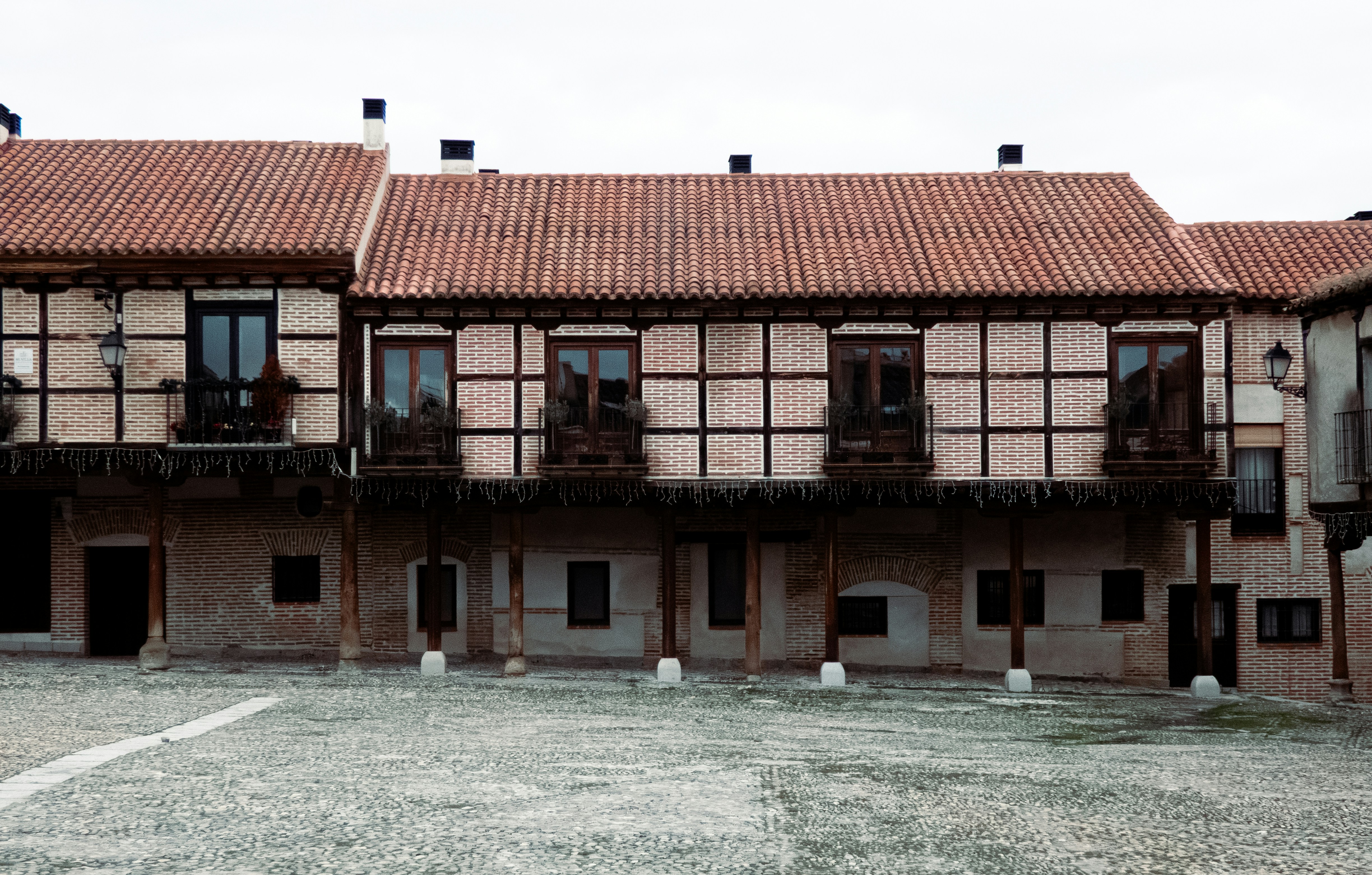 Old-world Facade: Timbered Hall Under a Red-tiled Sky