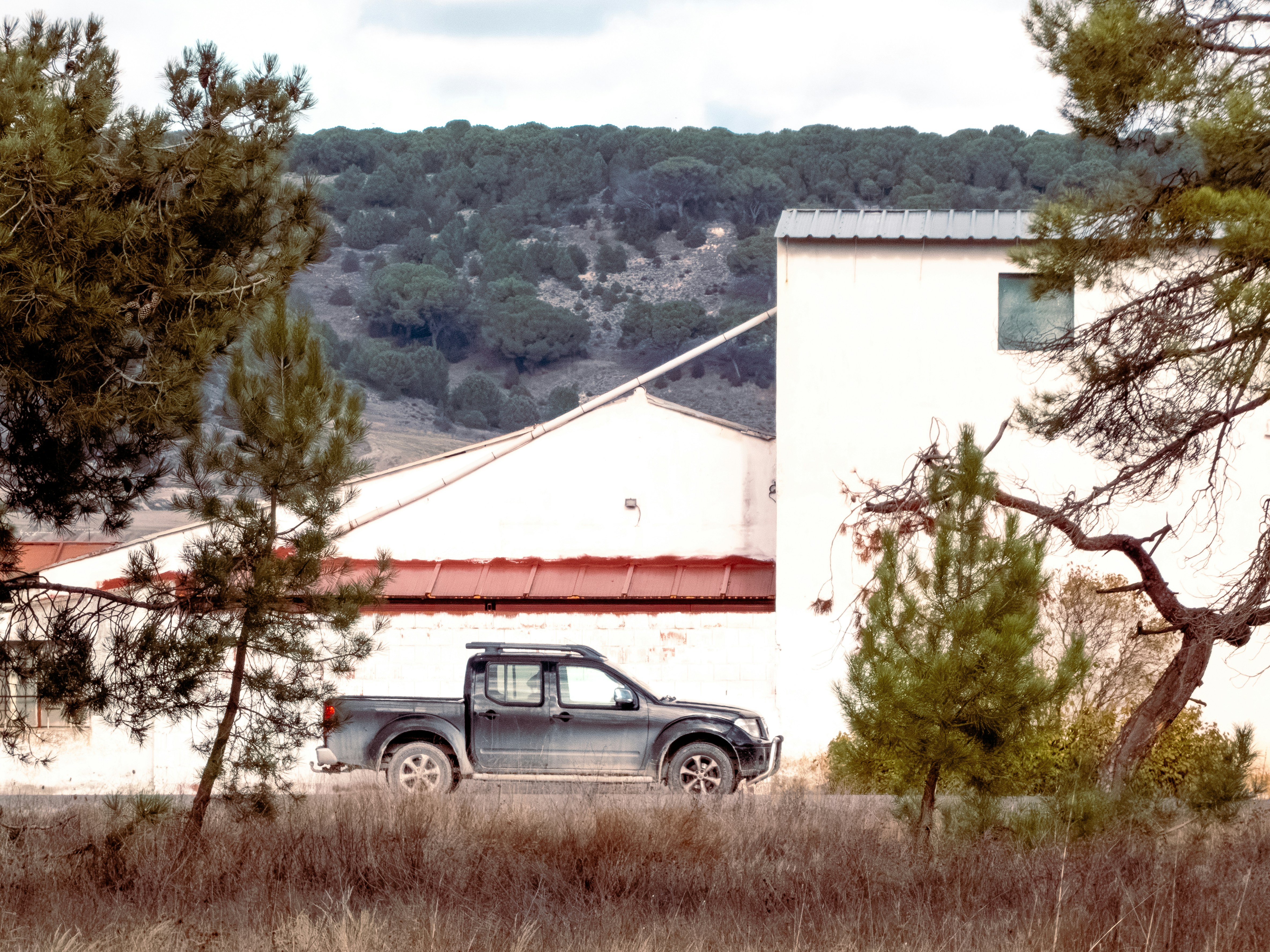 Rugged Pickup Beside a Quiet Farmstead