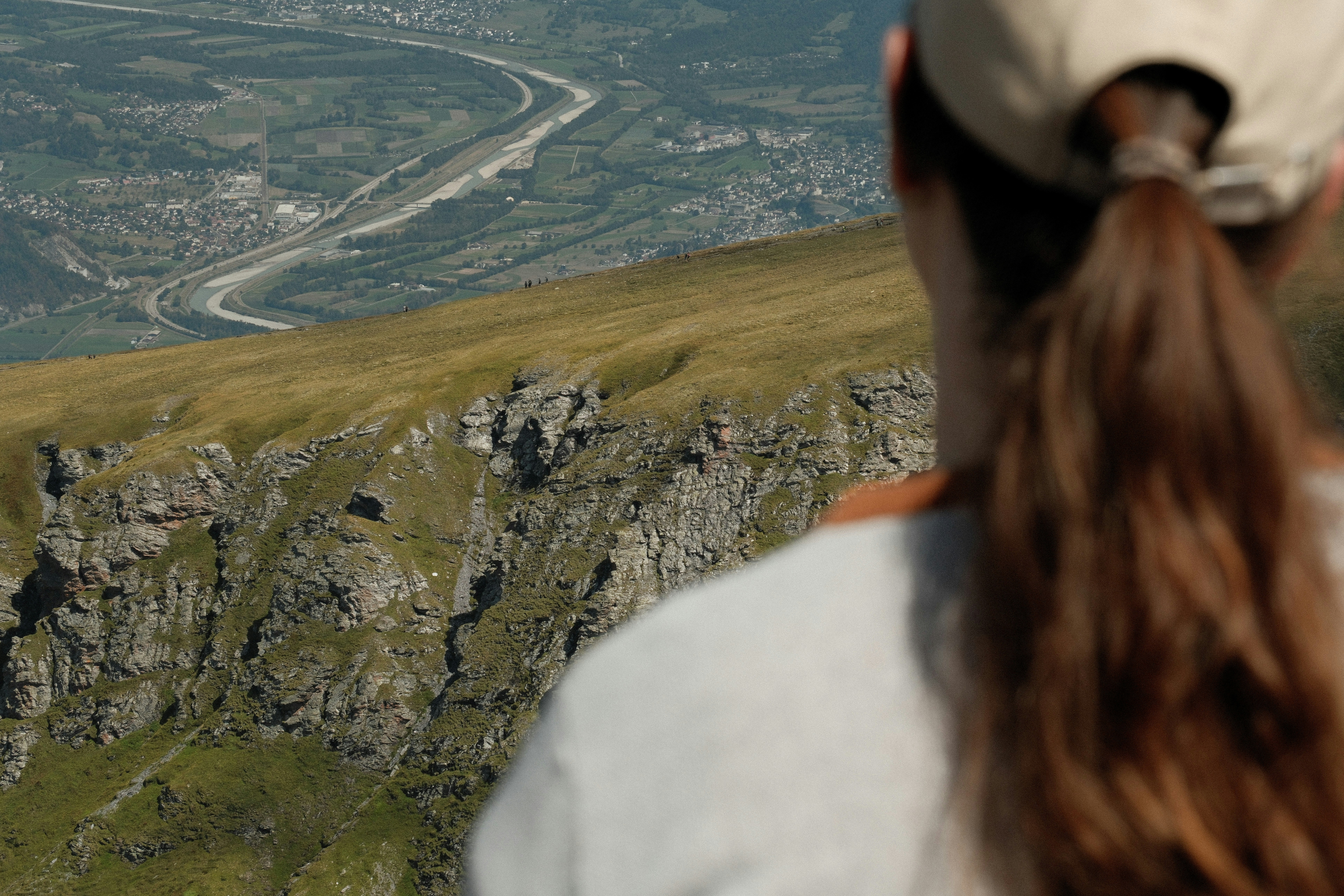 Overlook from the Ridge: A Hiker Gazes toward Streamlined Valleys