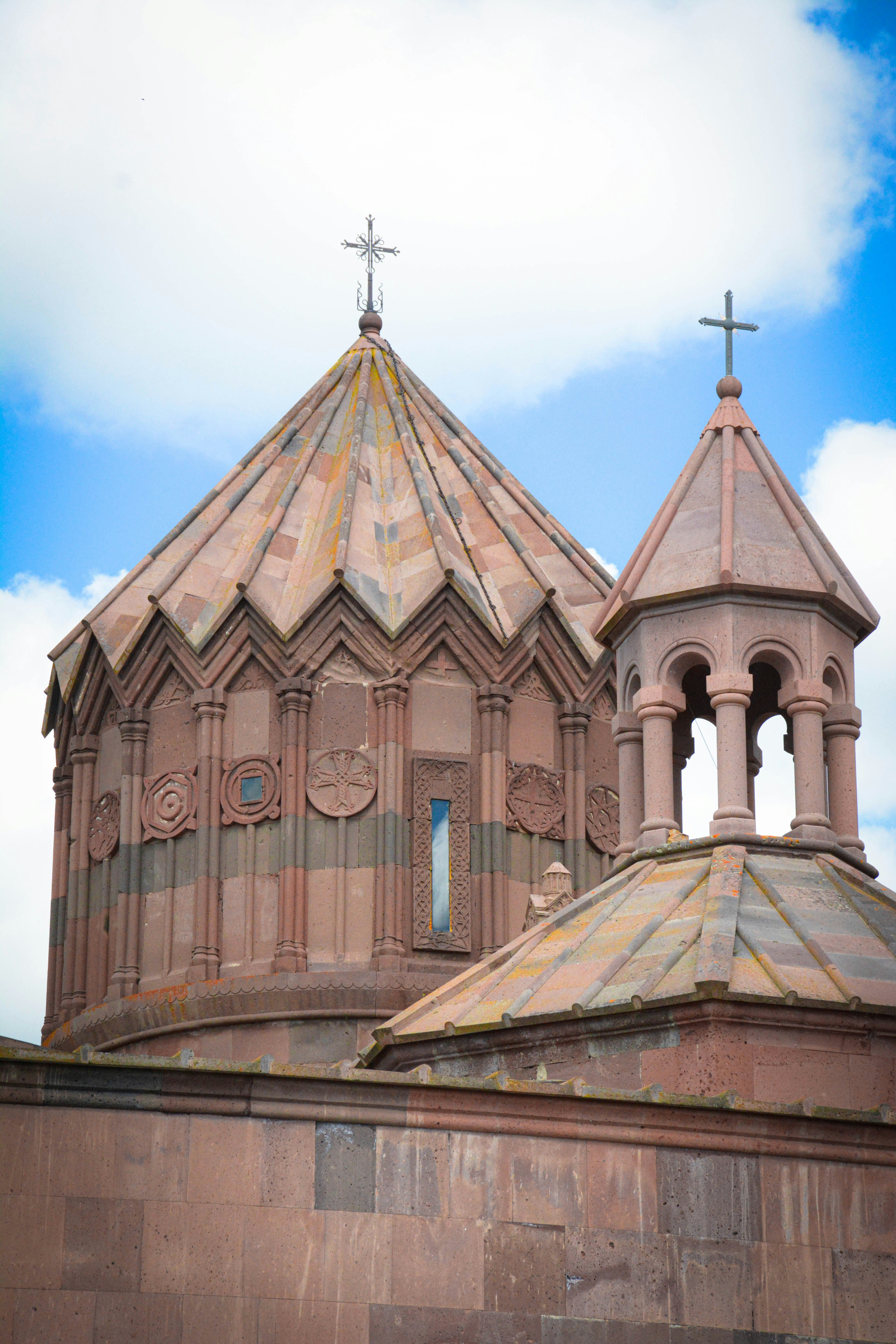 Stone Cathedral Roofs Under a Bright Arc of Sky