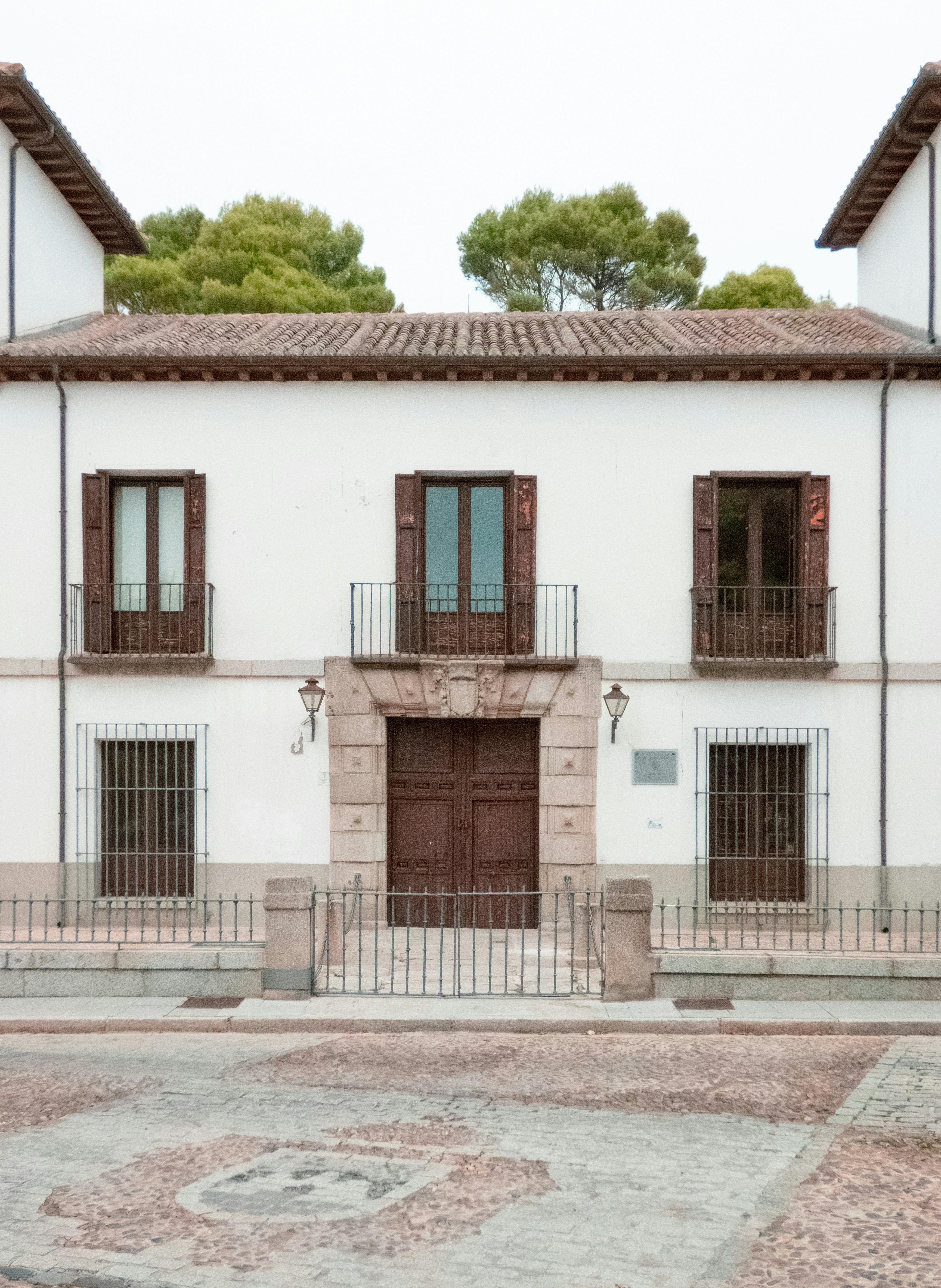 Symmetrical Heritage: A Central Doorway Framed by Windows and Ironwork