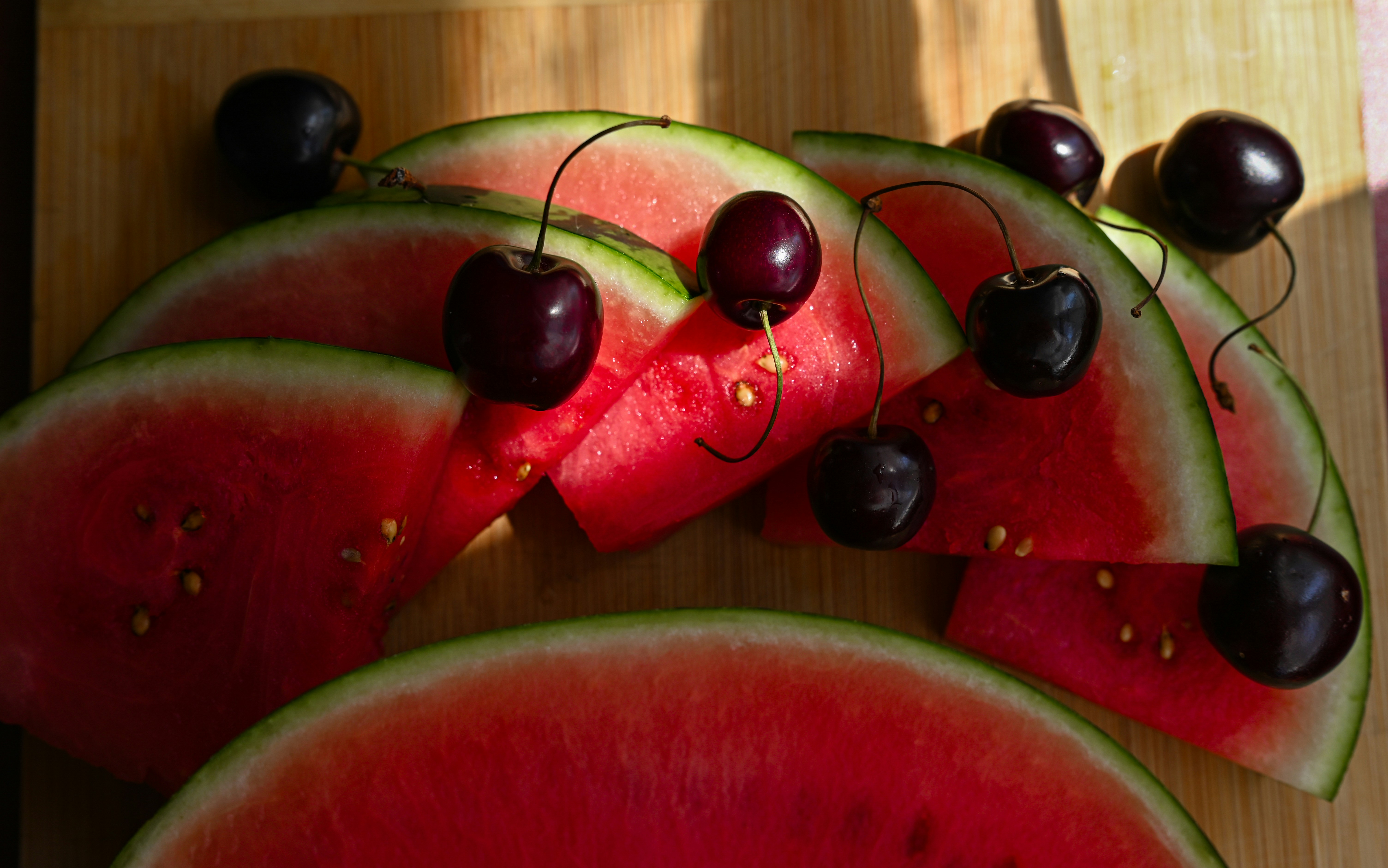 Juicy Geometry: Watermelon Slices and Cherries on a Wooden Stage