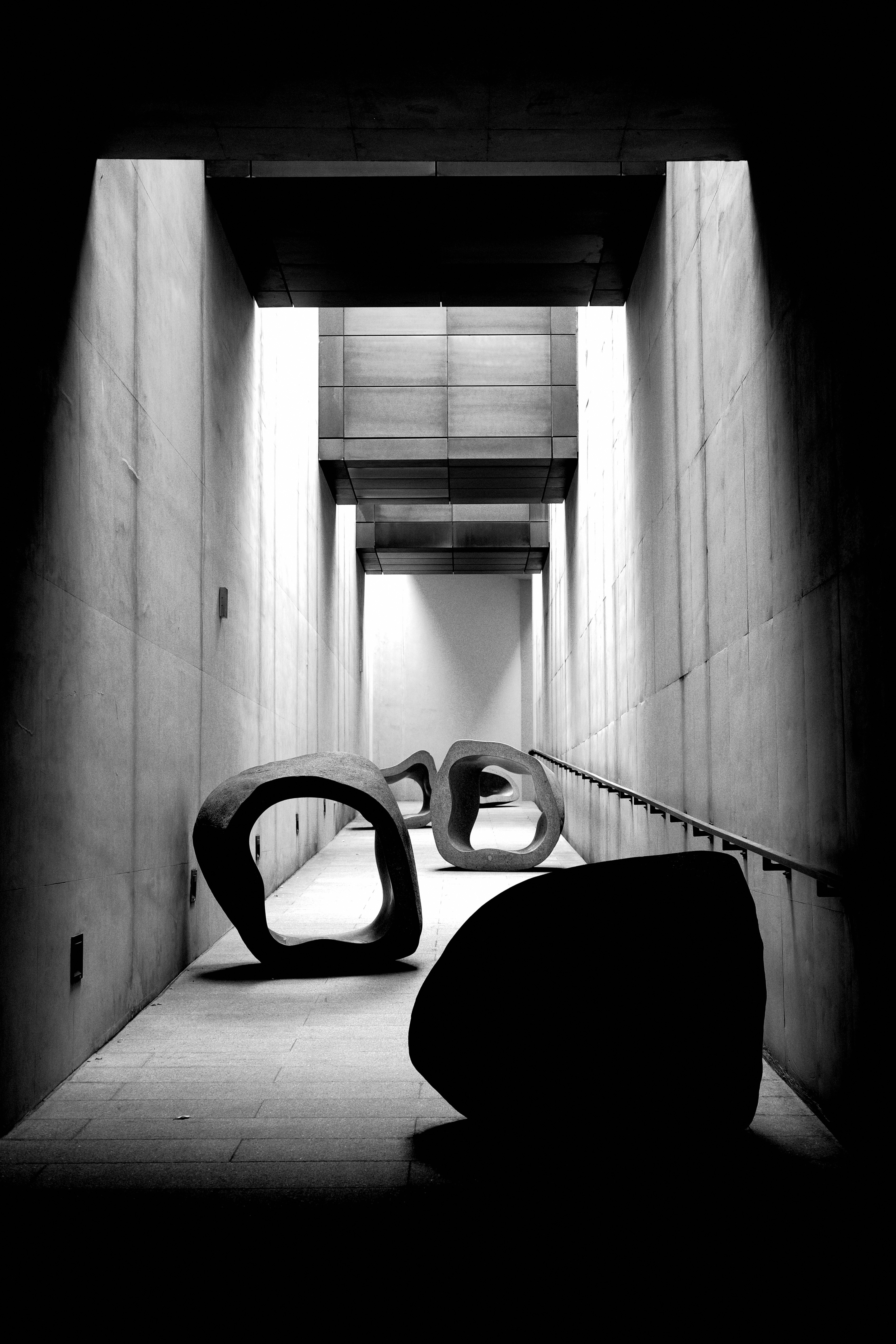 Monolithic Silence: Abstract Sculptures in a Concrete Corridor