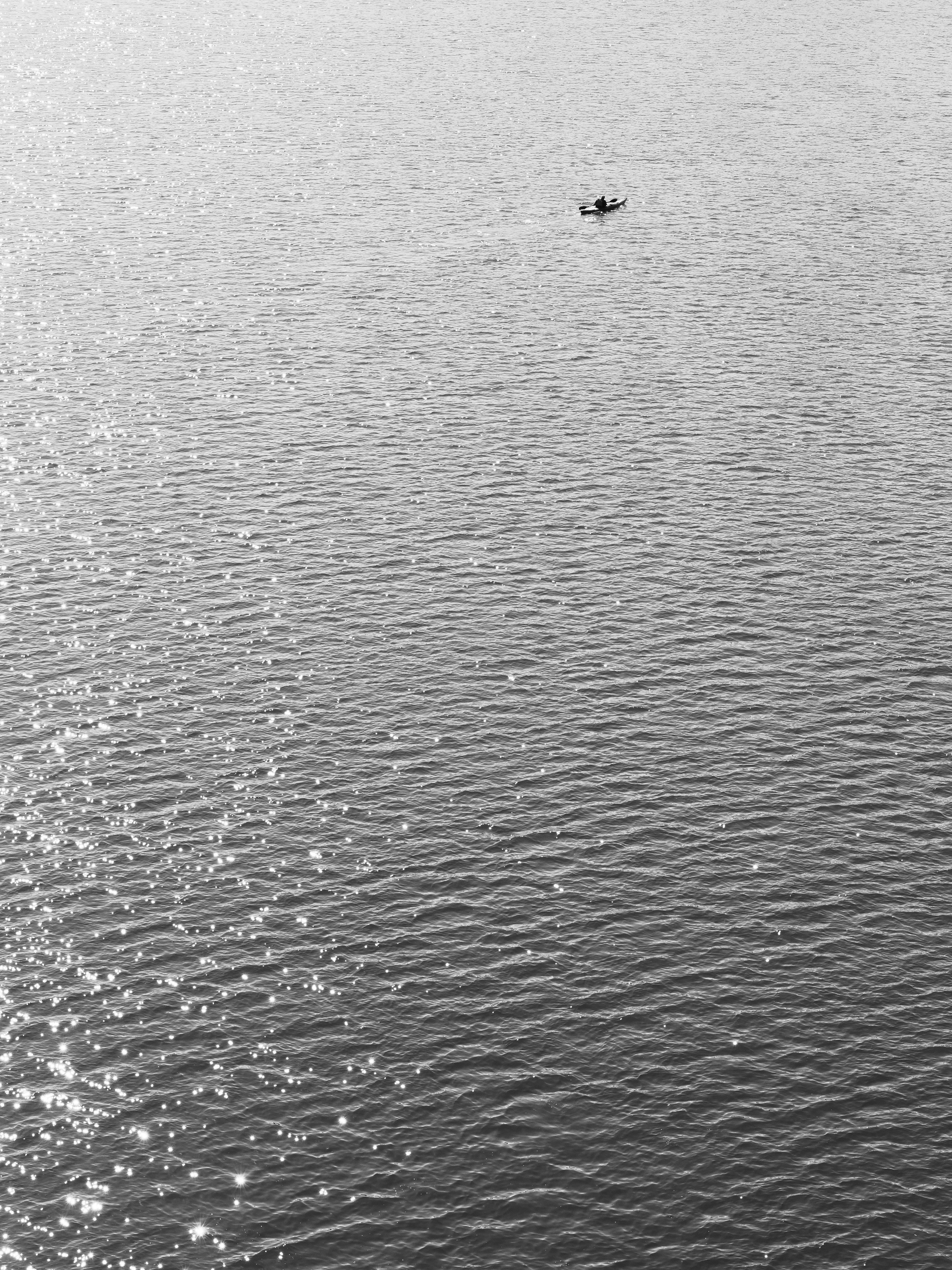 A lone boat on glimmering water