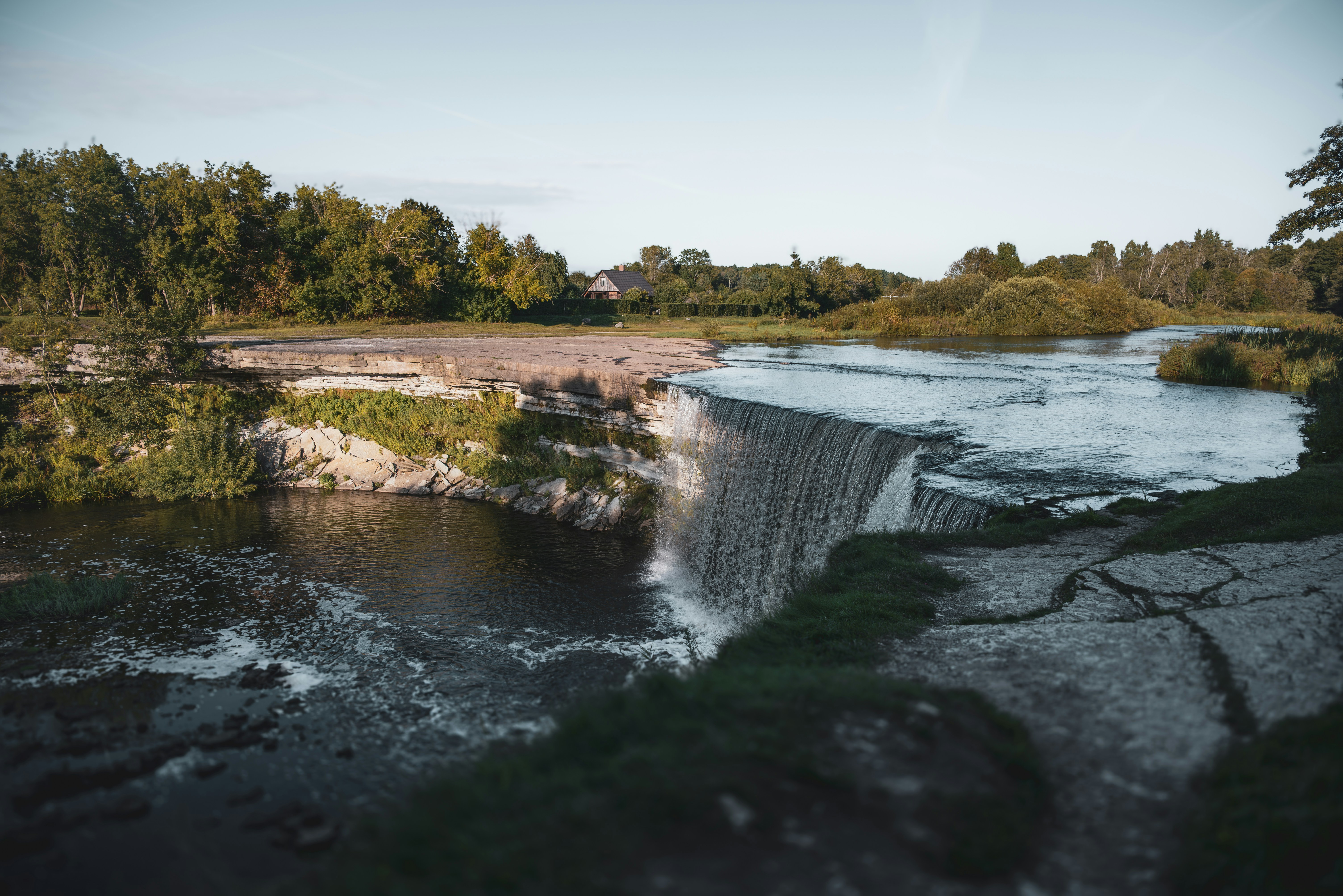Waterfall Edge at Sundown Over a Quiet River