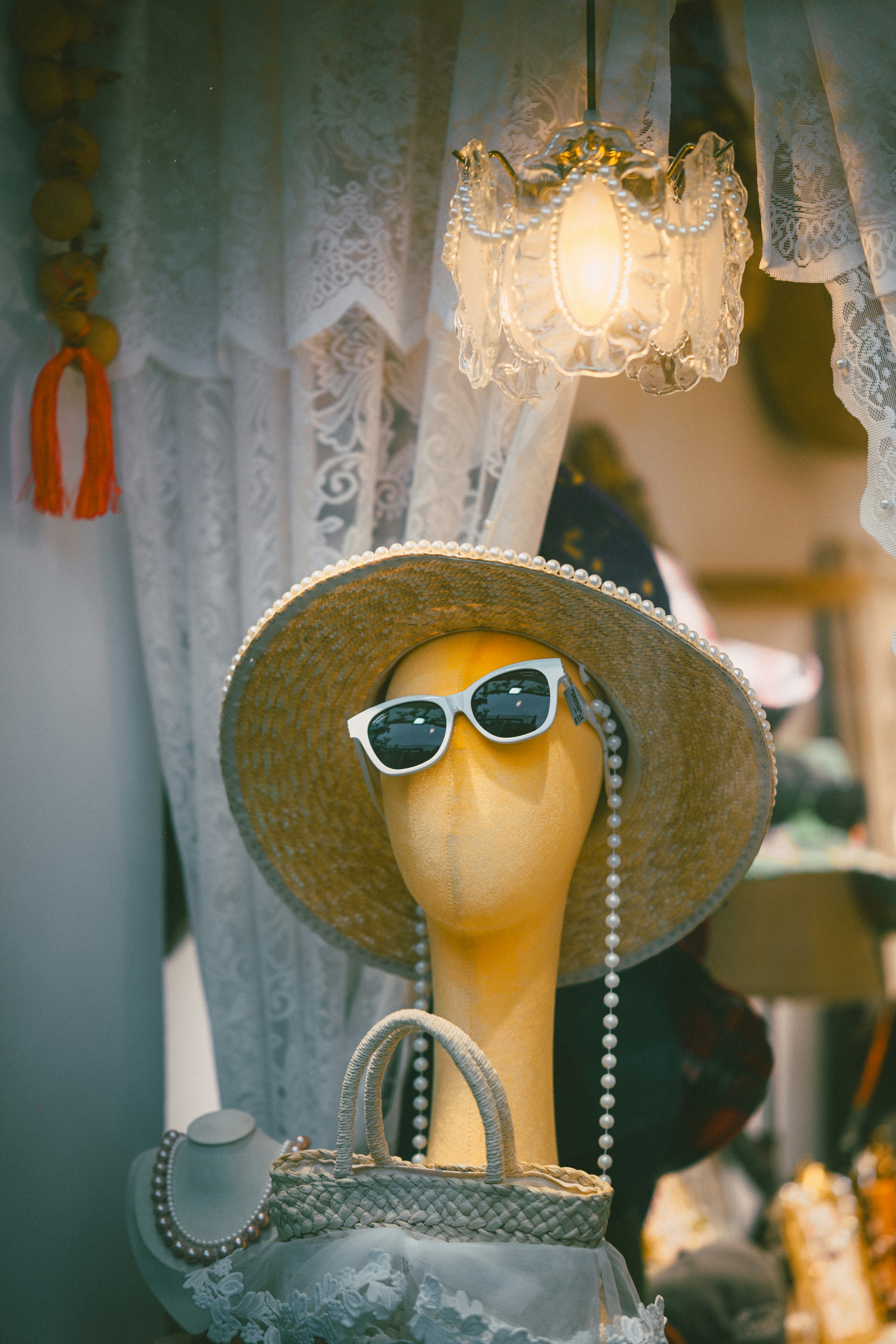 Straw Hat Glam: Sunglasses and Lace Under the Soft Shoplight