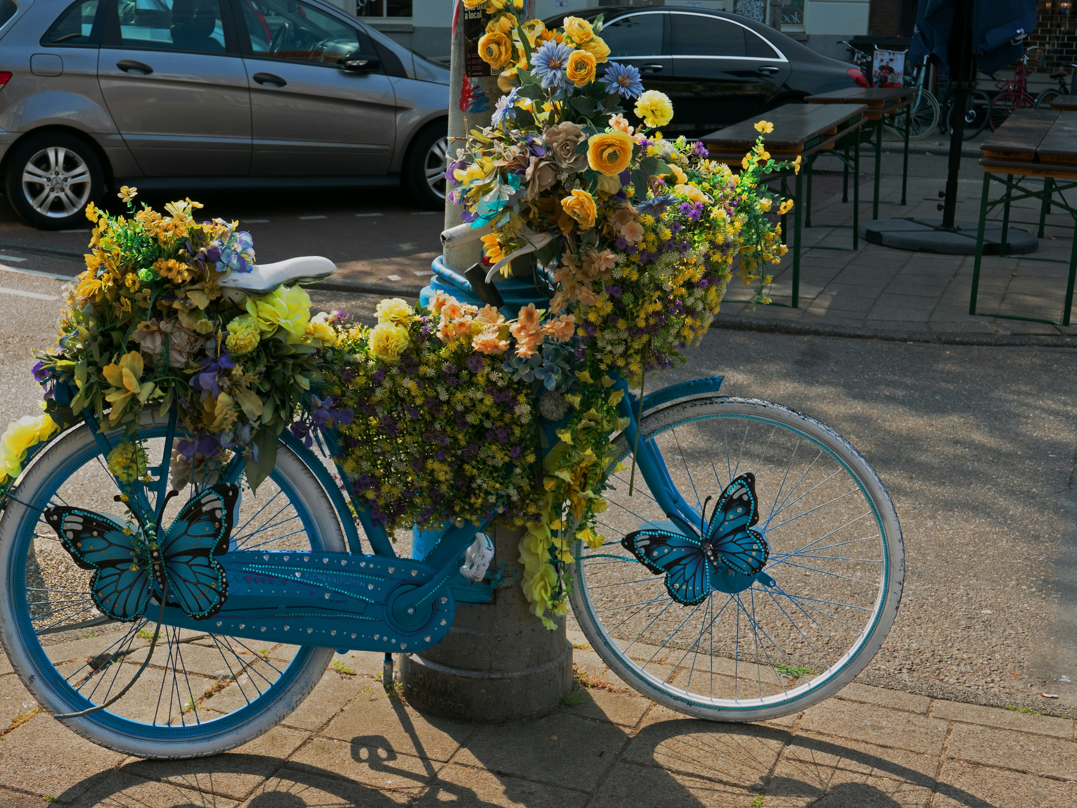 Blue Bicycle of Blooms in a City Square