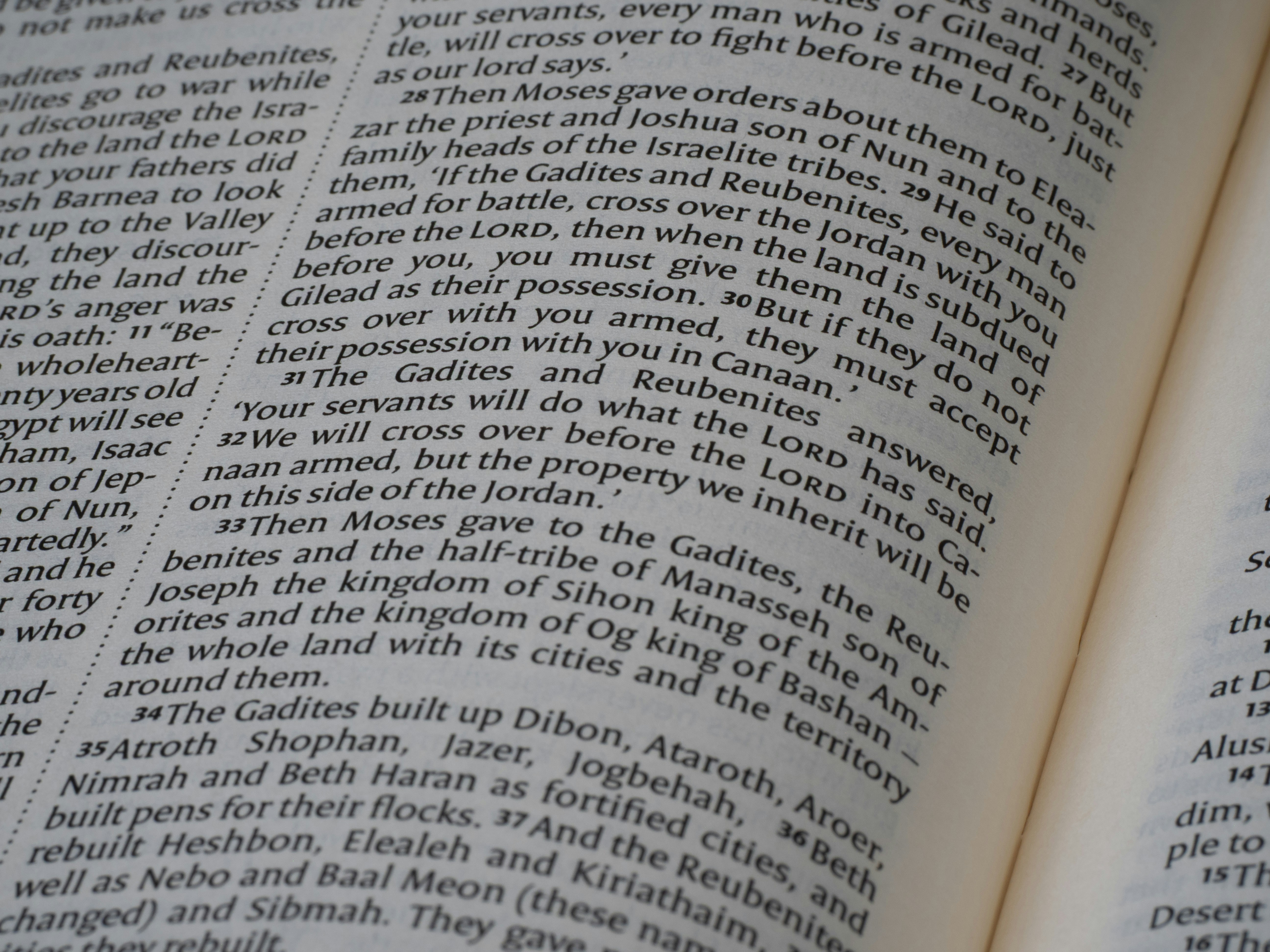 Close-up of aged printed text curling along a page edge, emphasizing the texture and script without a visible subject. The image is a printed page, highlighting the tactile lines and shadowed indentations.