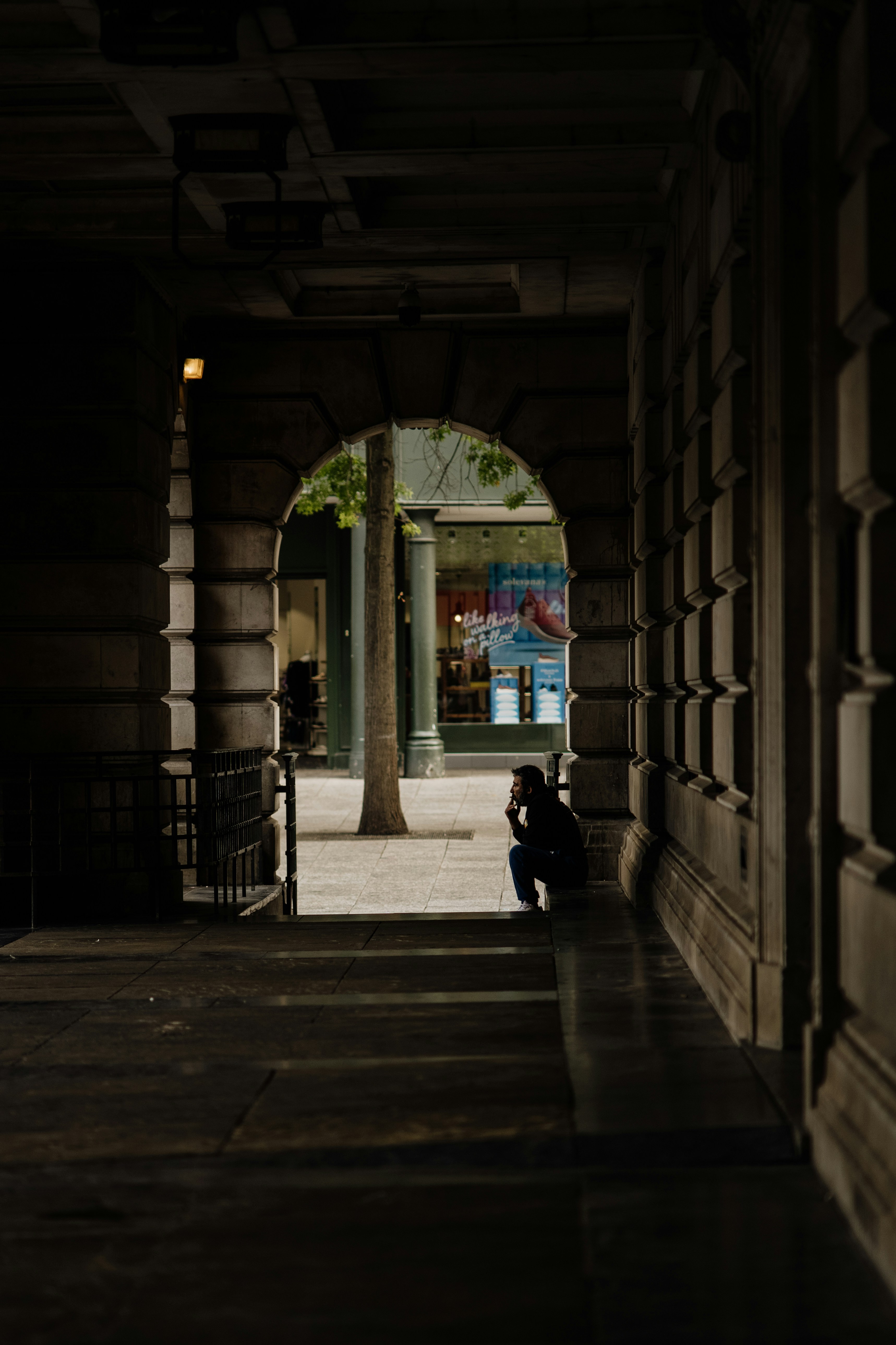 The Quiet Lumen: A Photographer in the Arched Alley