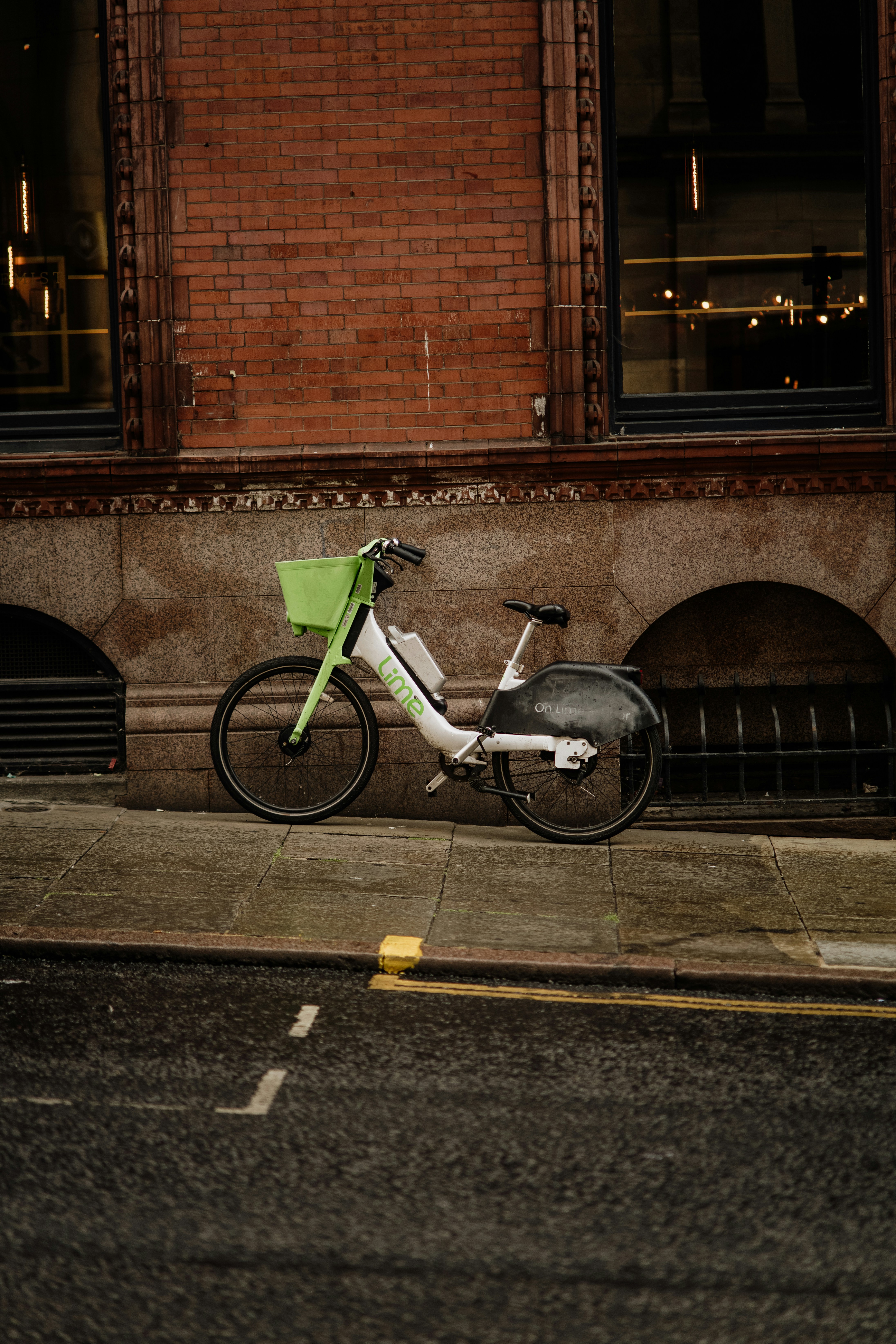 City Bike in Focus: A Lime-green Courier by the Brick Facade