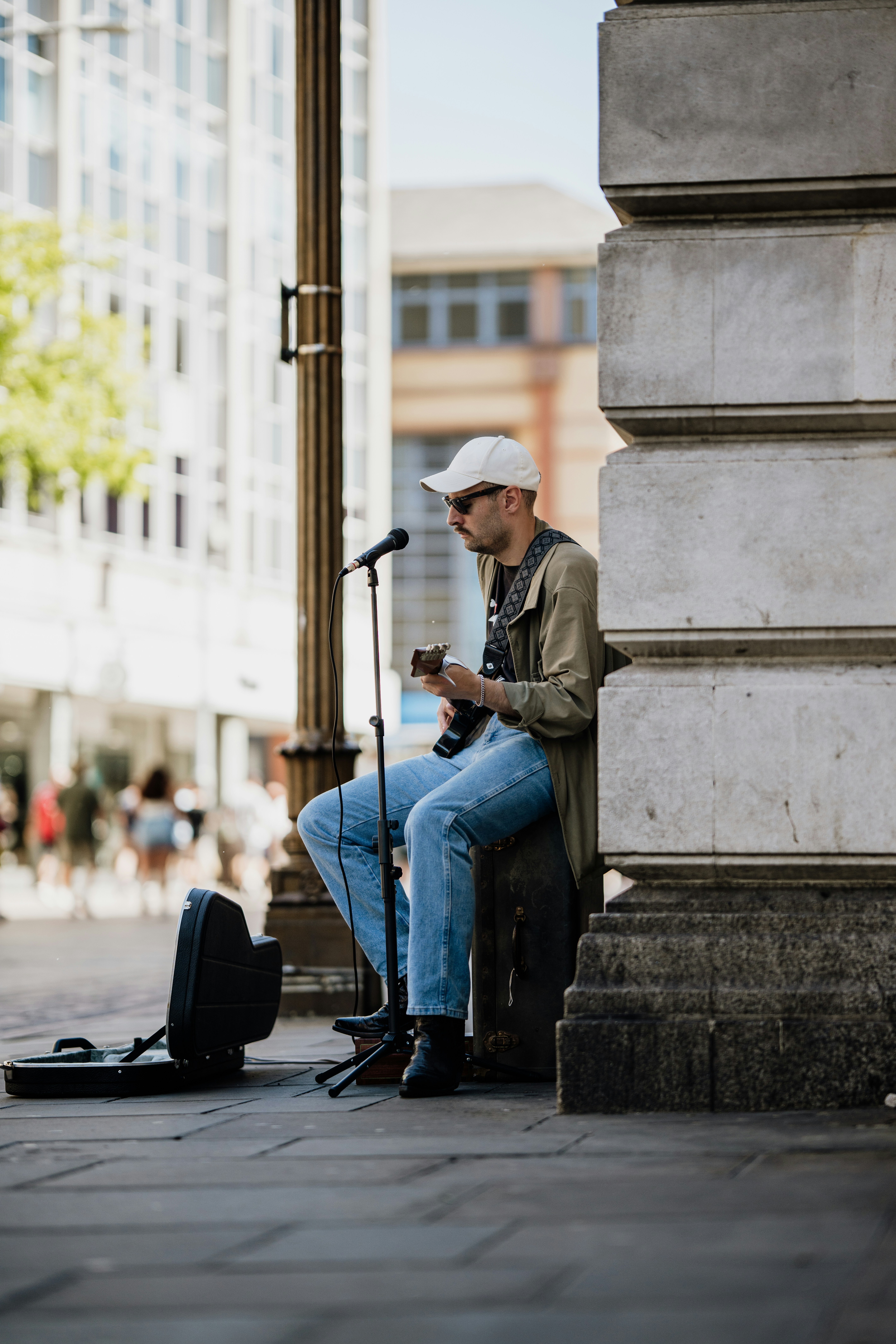 Street Serenade: Guitarist on a City Stone Bench