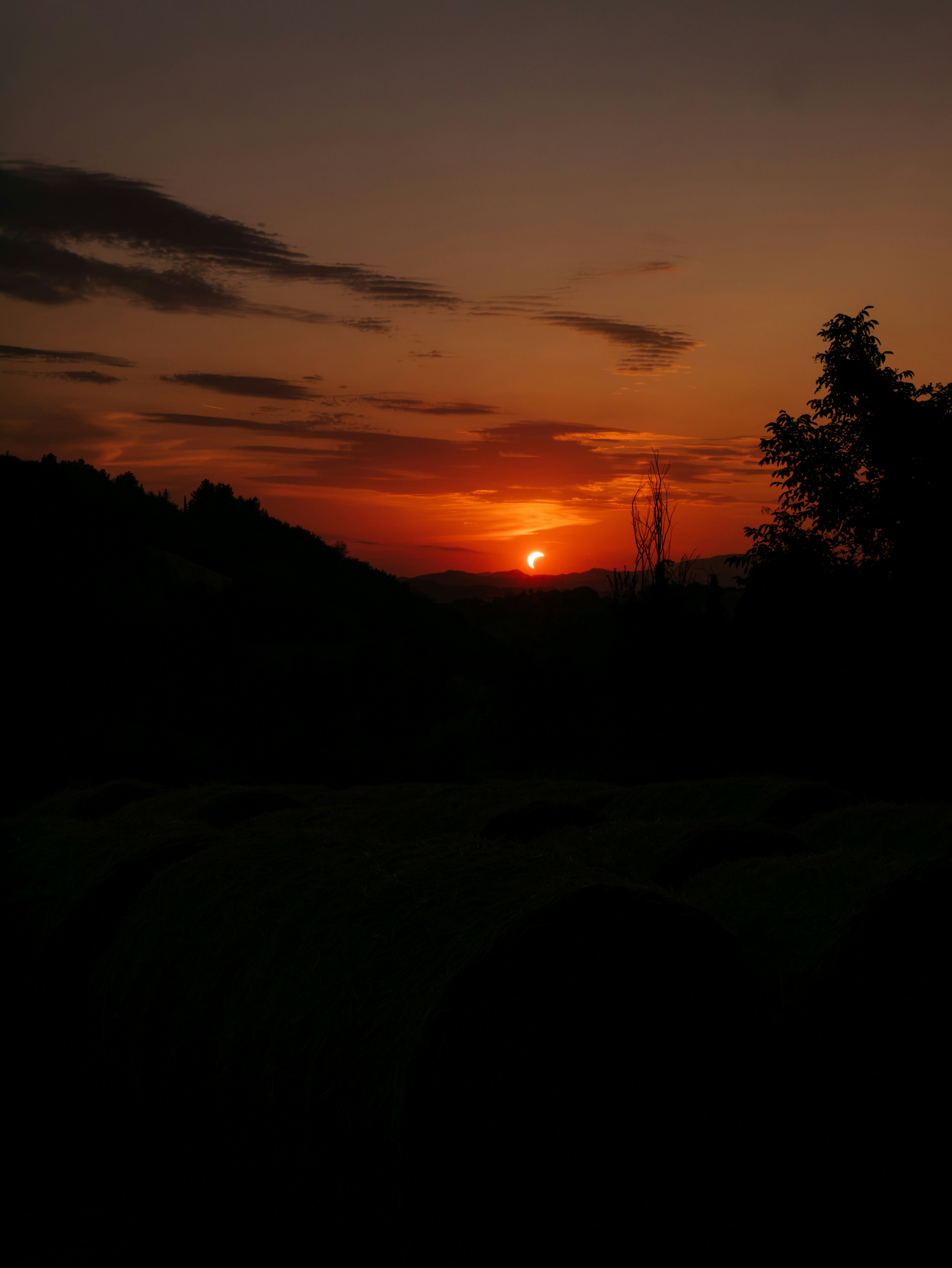 Sunset on the Horizon: silhouetted landscape under a fading amber sky