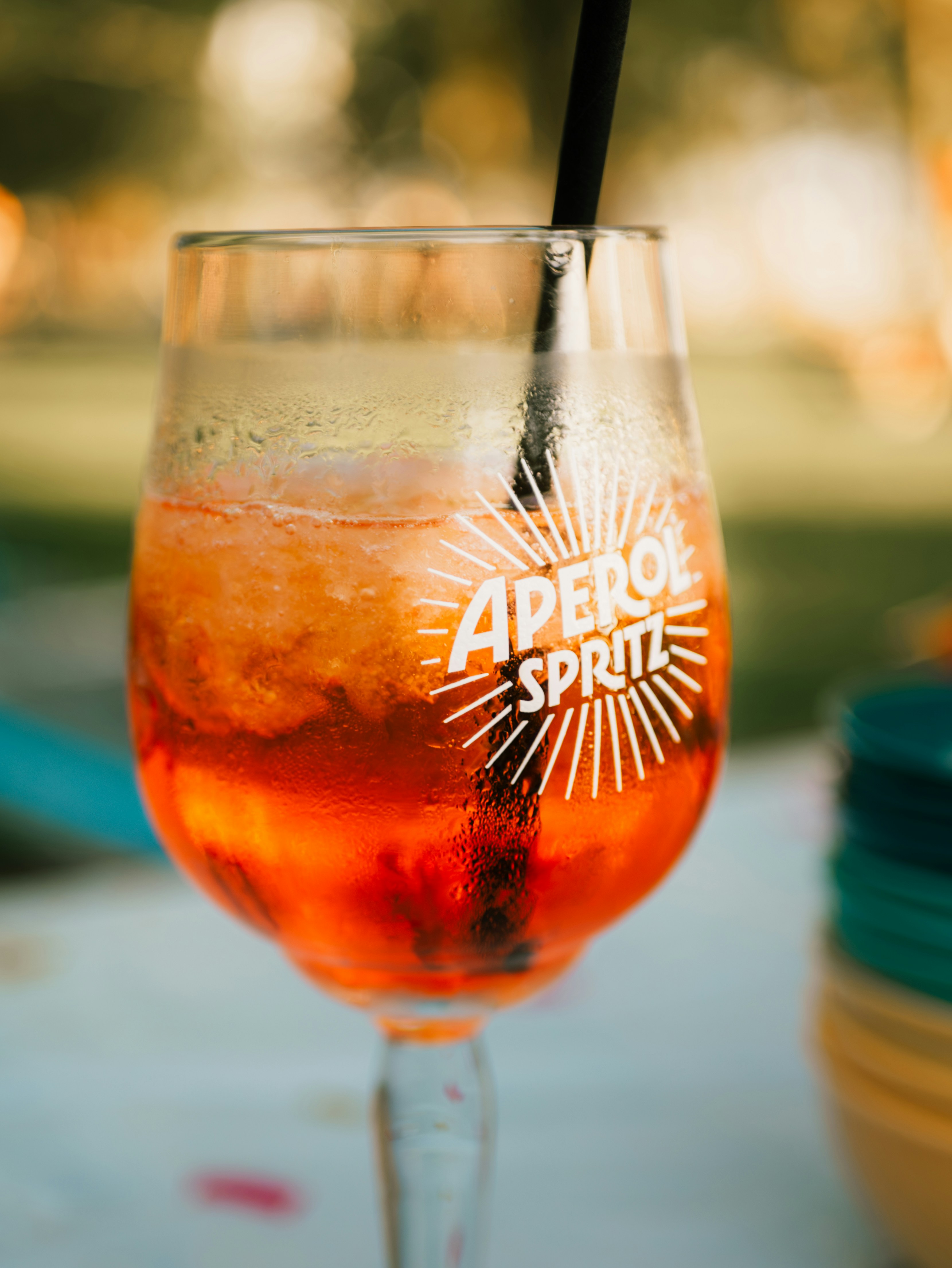 Sunlit Aperol Moment: Glass with Striking Orange Glow