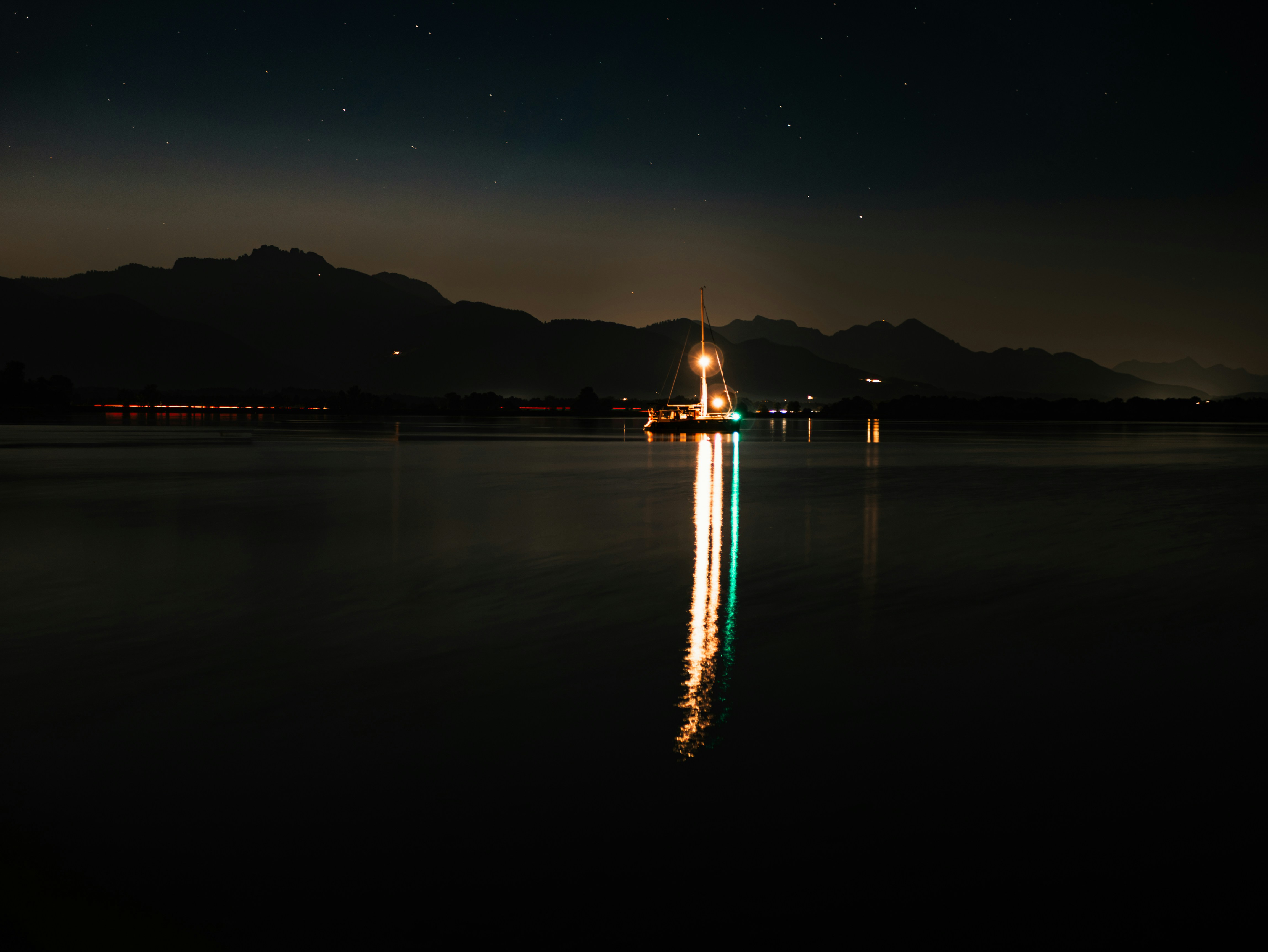 Night Sail: A Quiet Vessel Basks in Moonlit Reflections