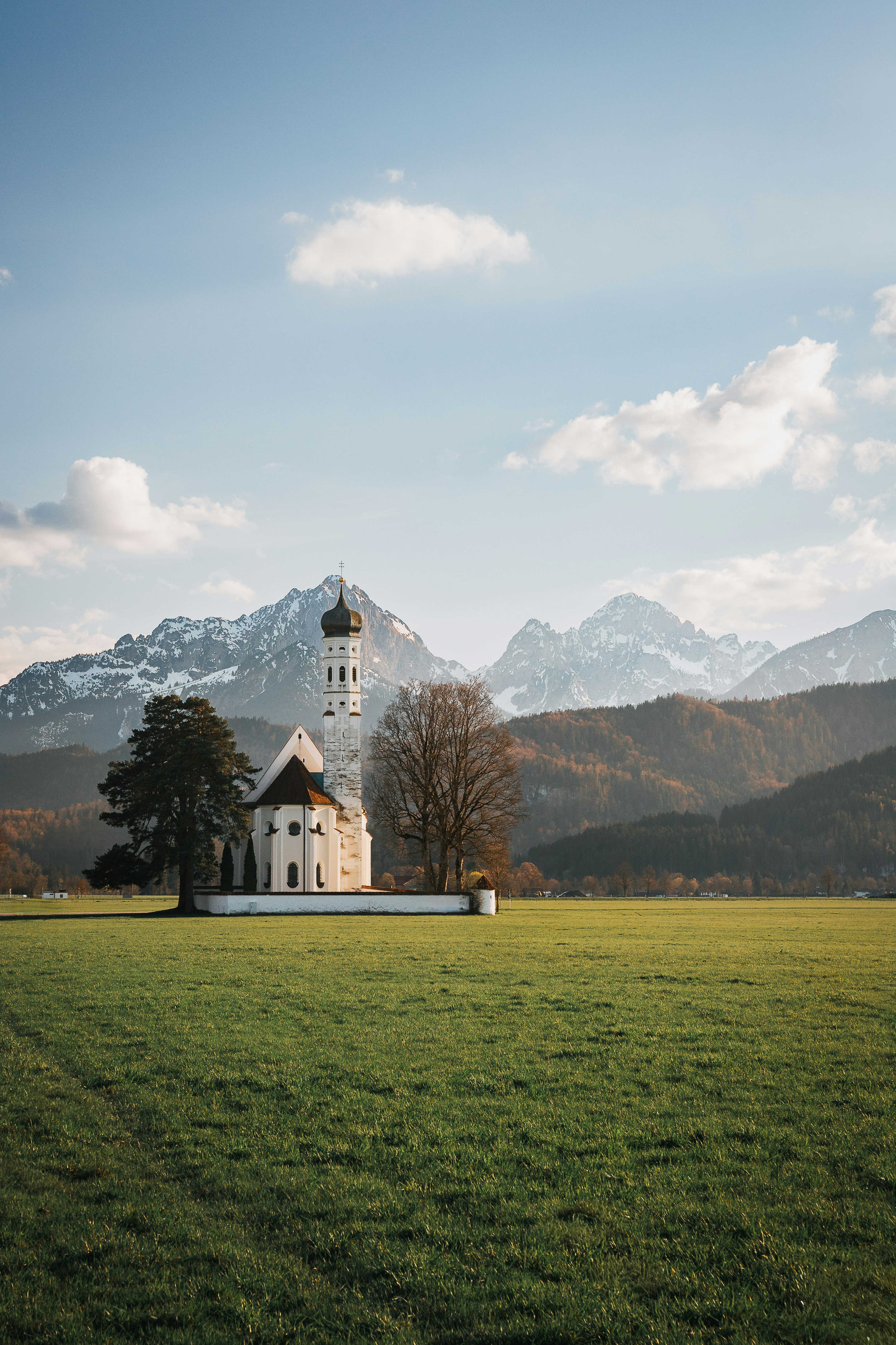 Lonely Chapel Amid Alpine Fields Under Wide Sky