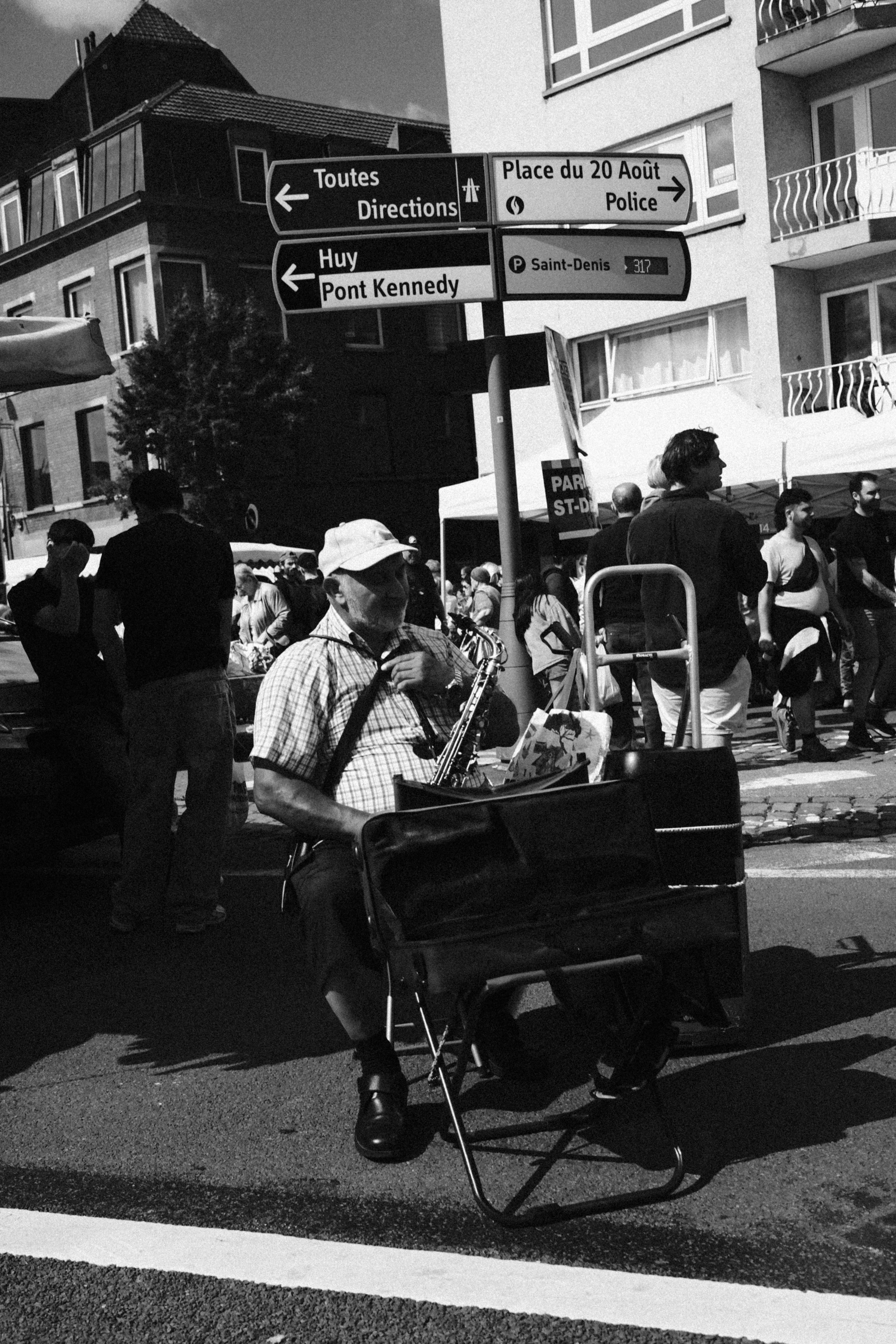 Street Busker Serenade Under a Signpost of Travel