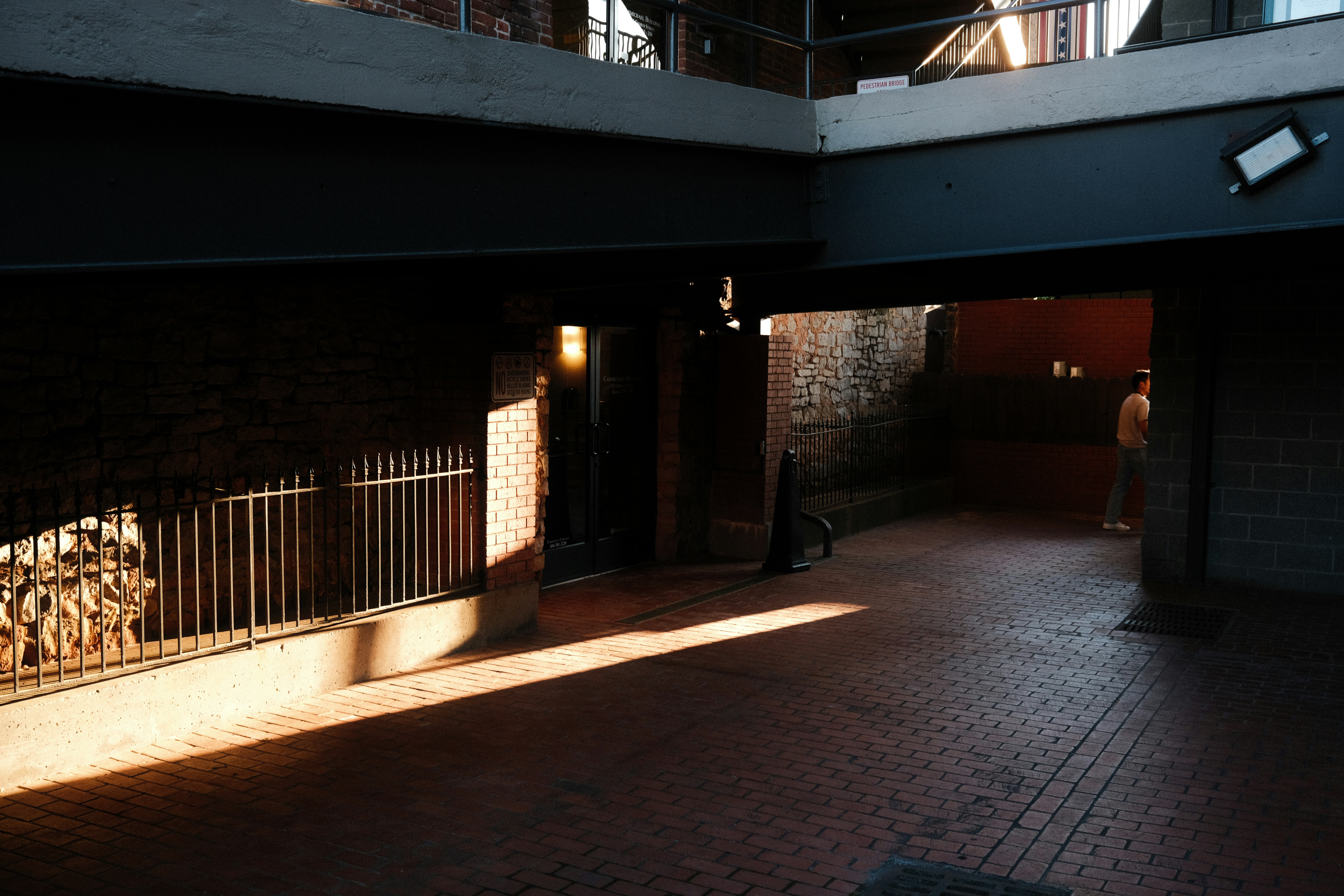 Shadowed Archway and Sunlit Brick Courtyard