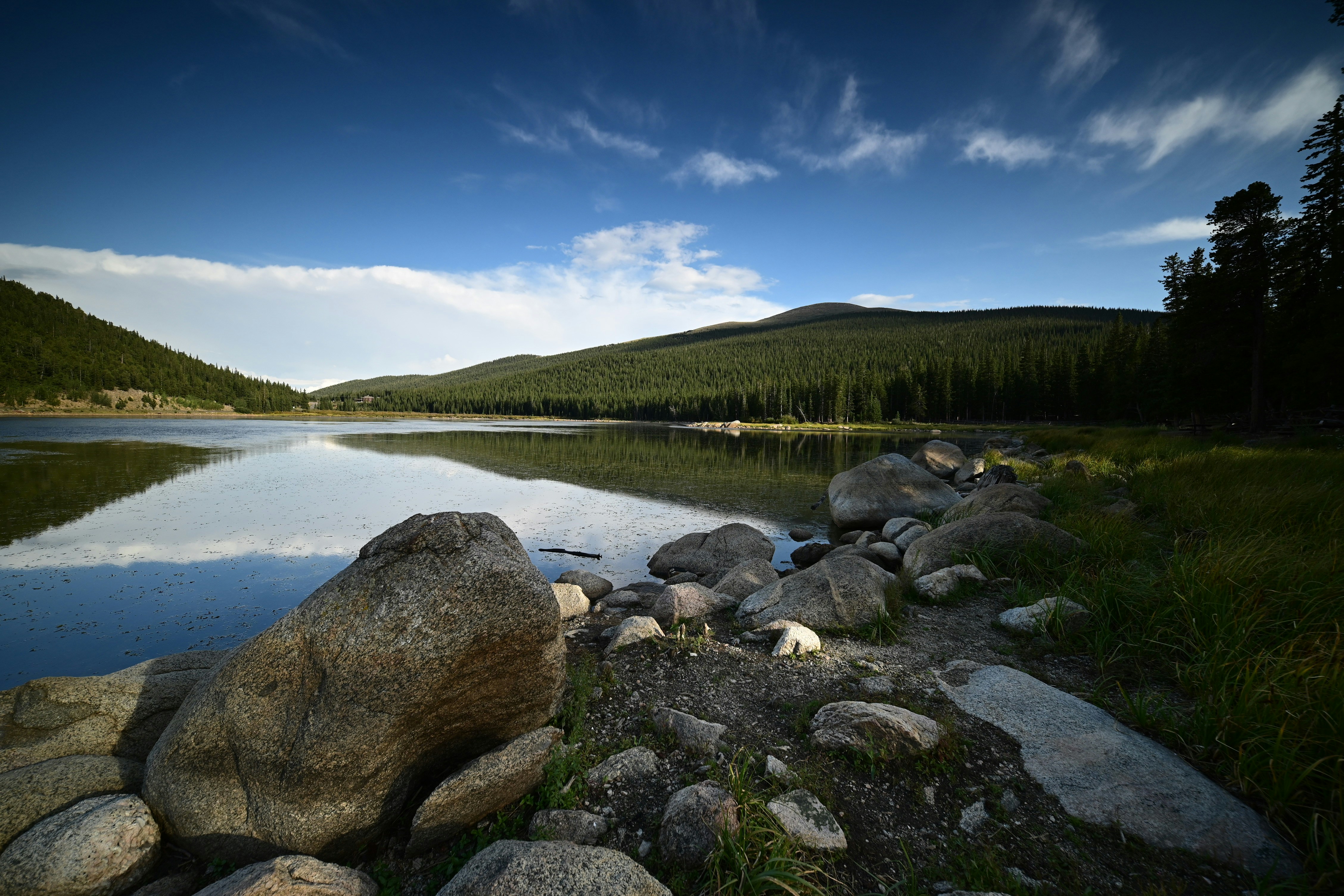 Serene River Bend: Stones, Sky, and Pines