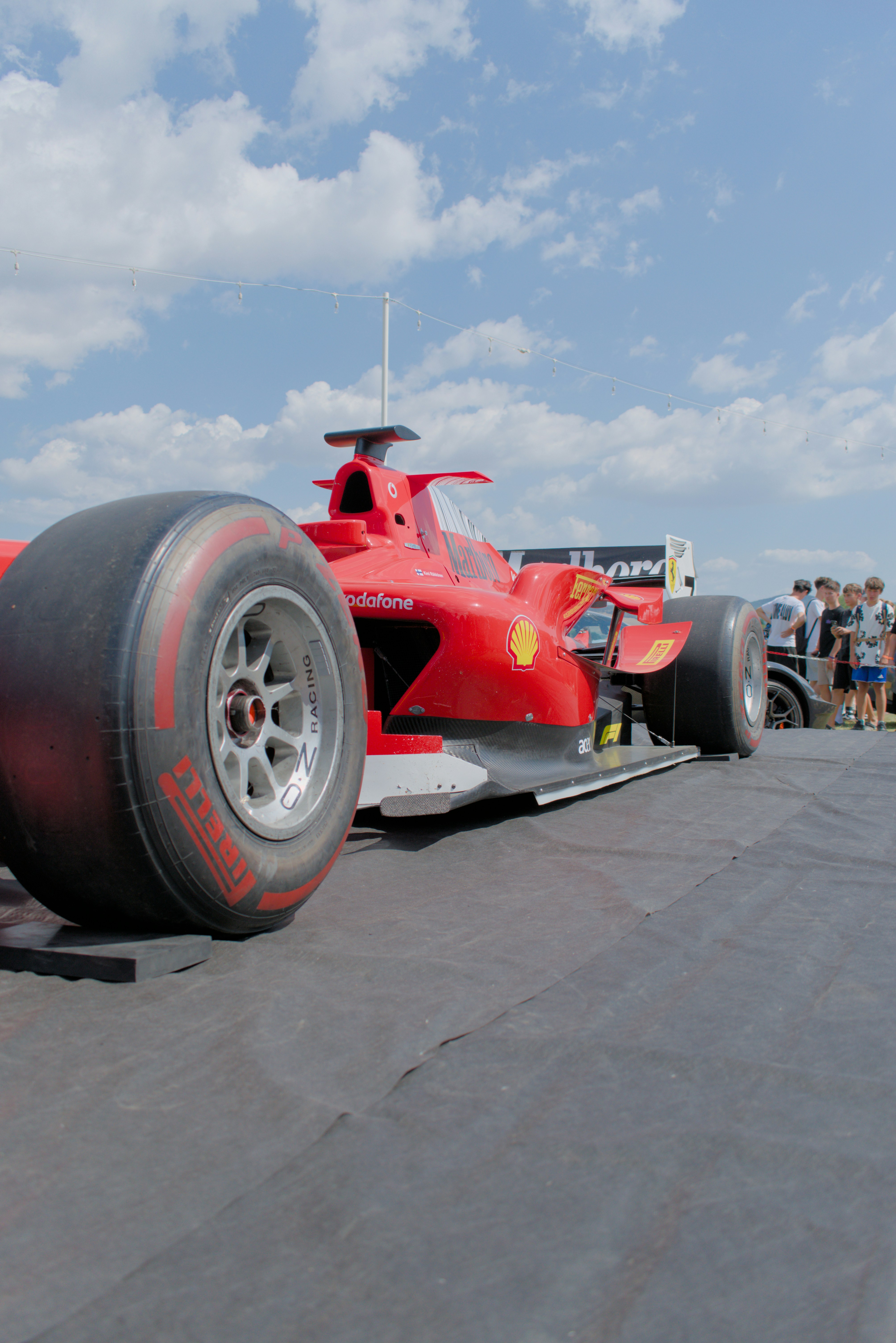 Red Formula: low-angle view of a Ferrari on display at the pit lane