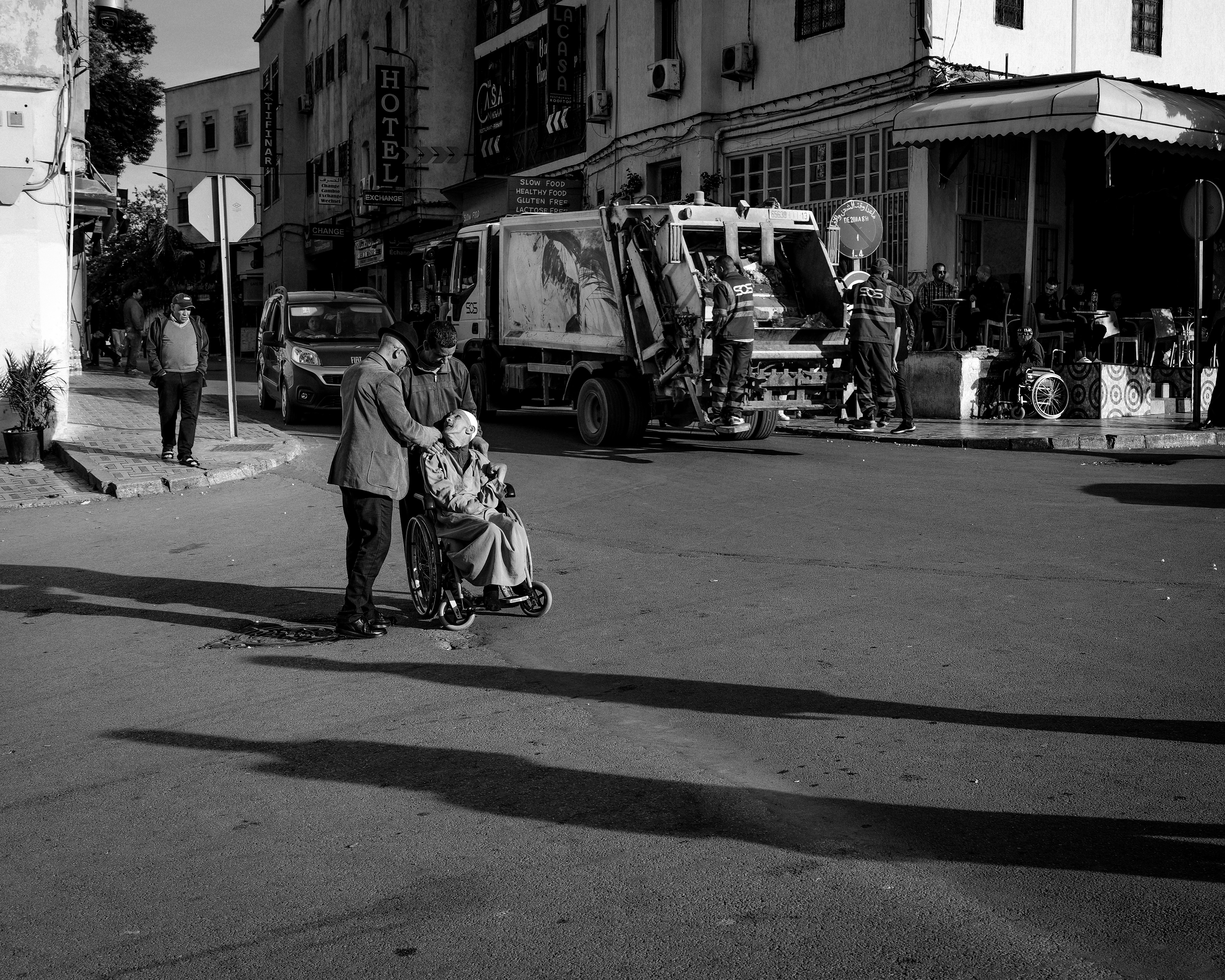 Wheelchair Serenade: A Quiet Moment Amid Street Turbulence