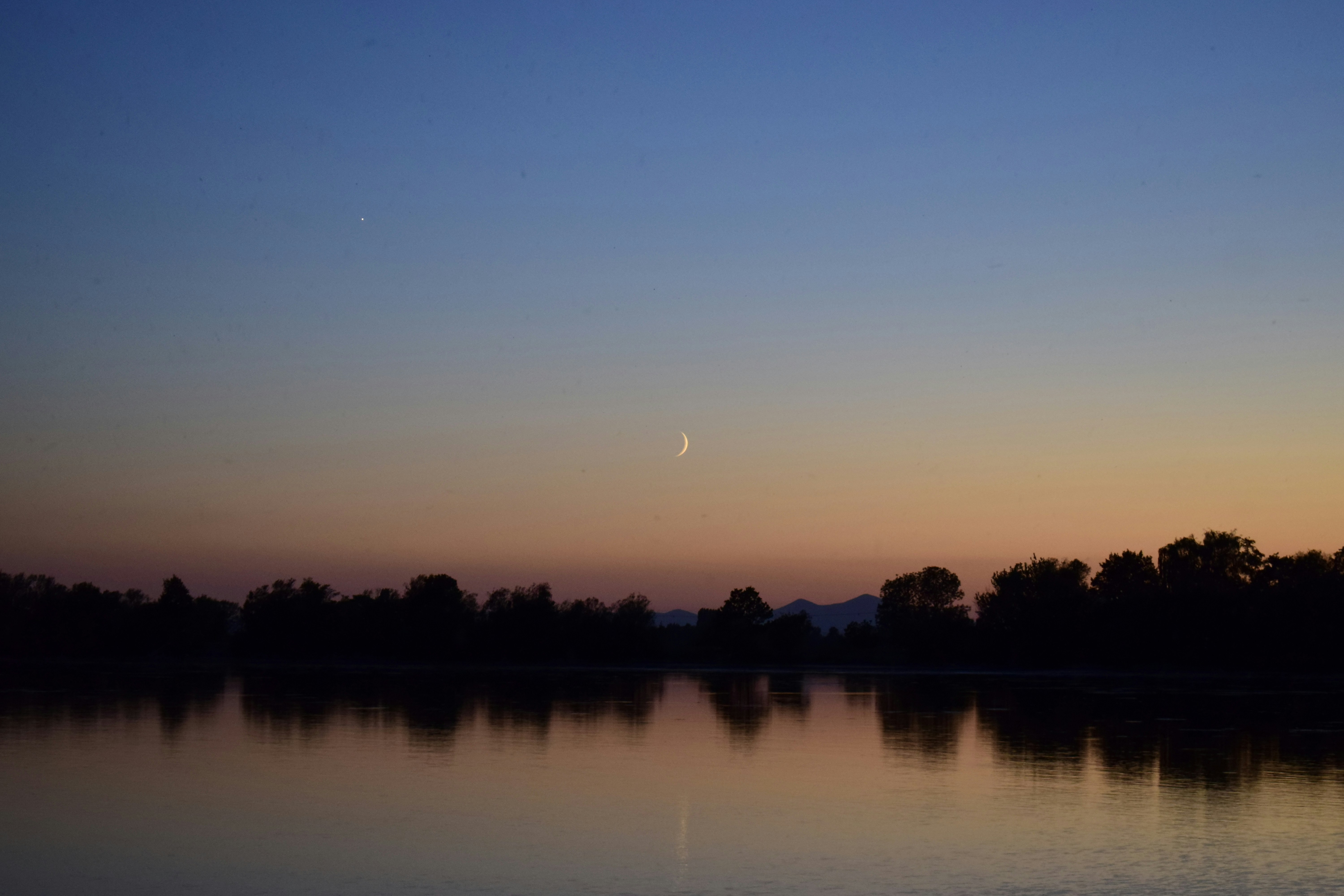 Dawn Crescent Over Quiet Waters