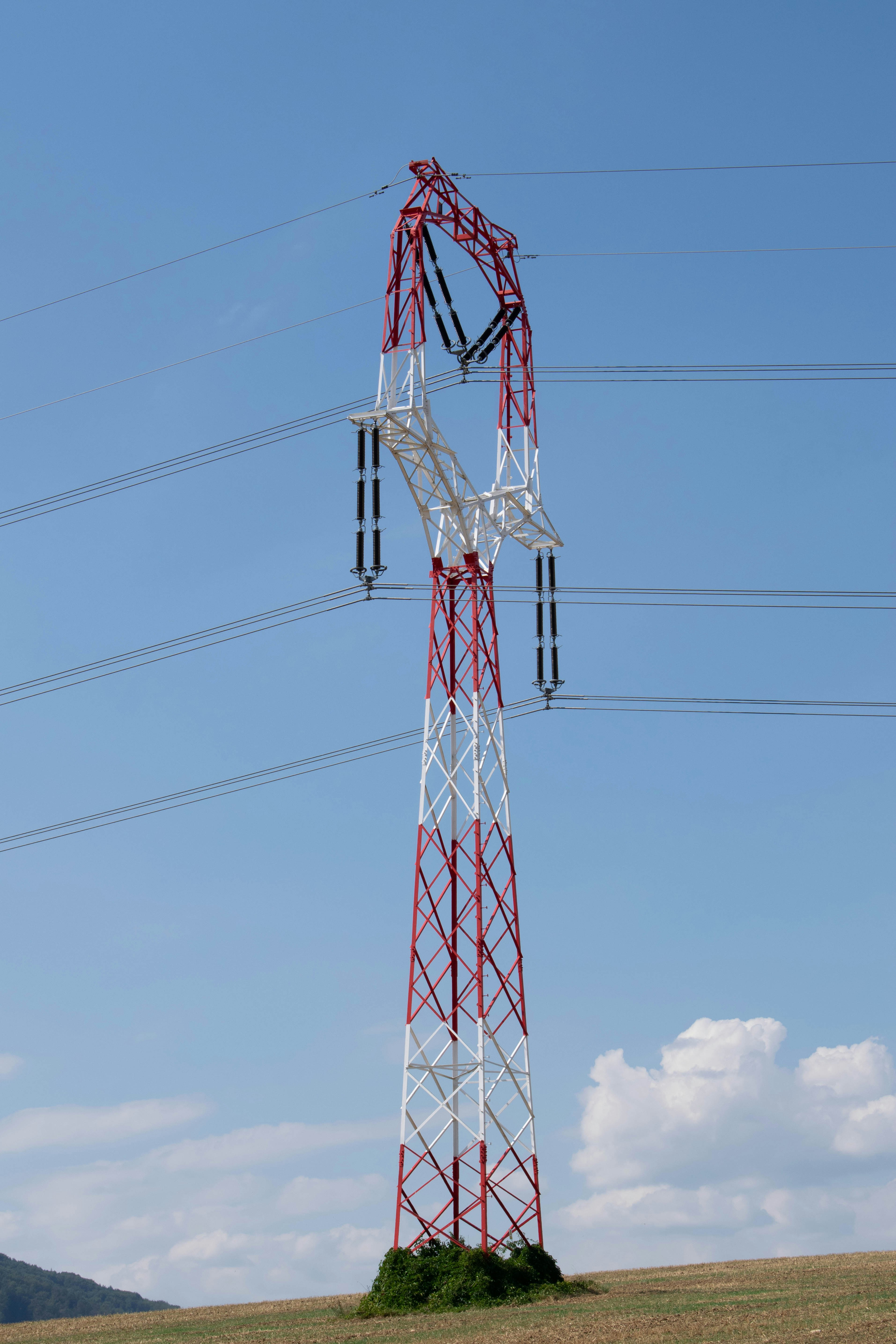 Towering Lattice: Red and White Transmission Amidst Open Skies