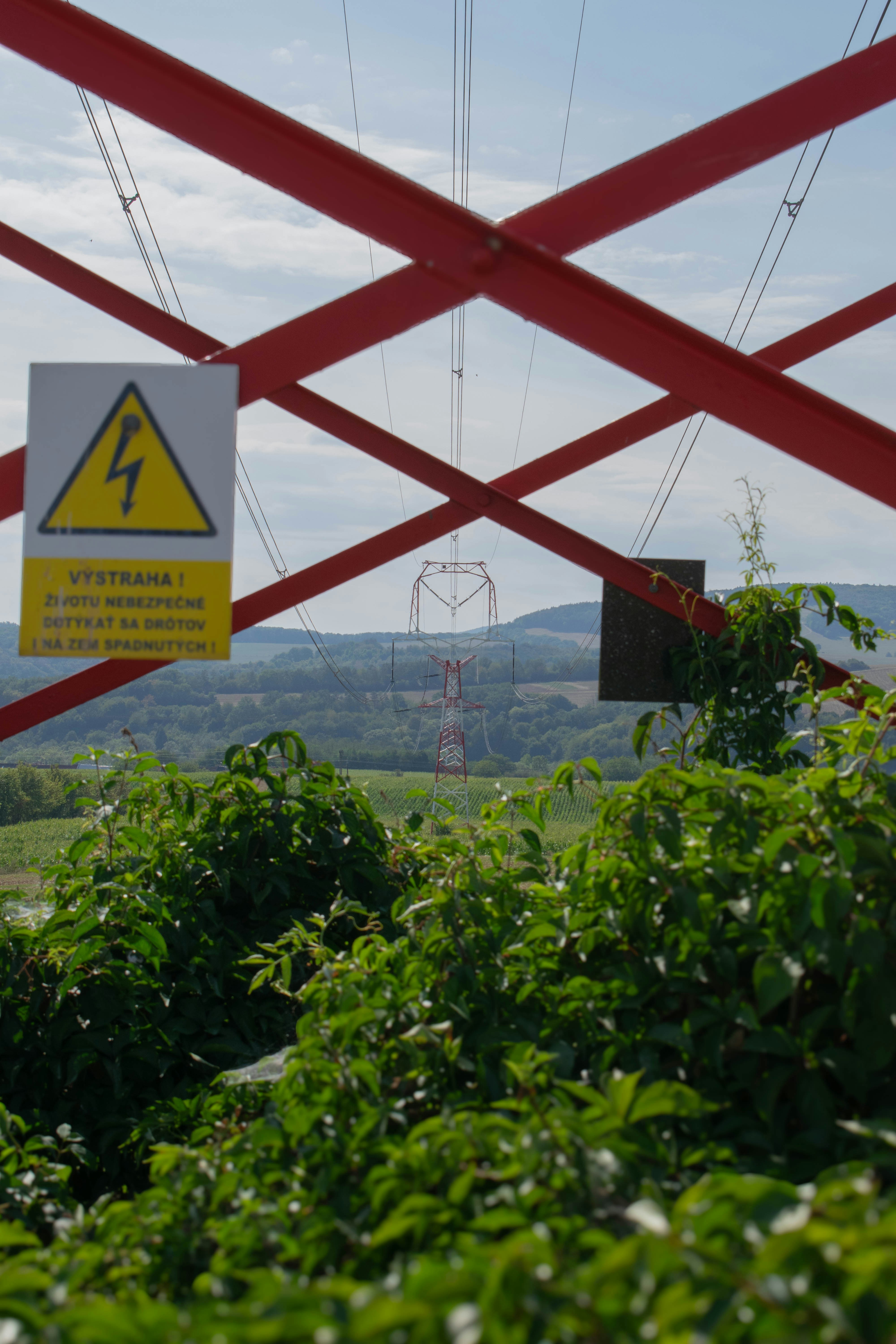 Red Crossed Rails Framing a Hazardous Panorama