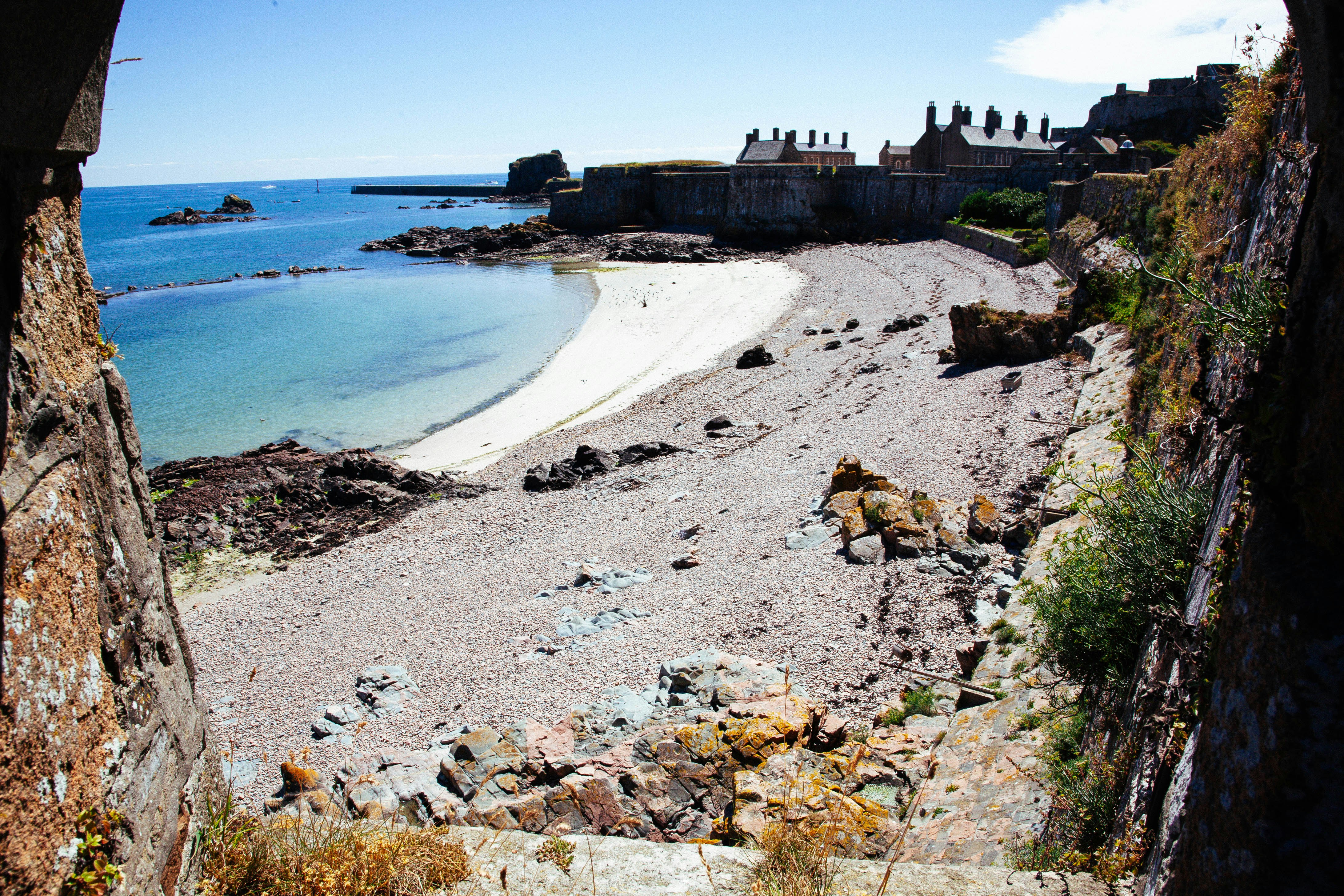 Cove of Stone and Sea: A Sunlit Beach through Coastal Aperture