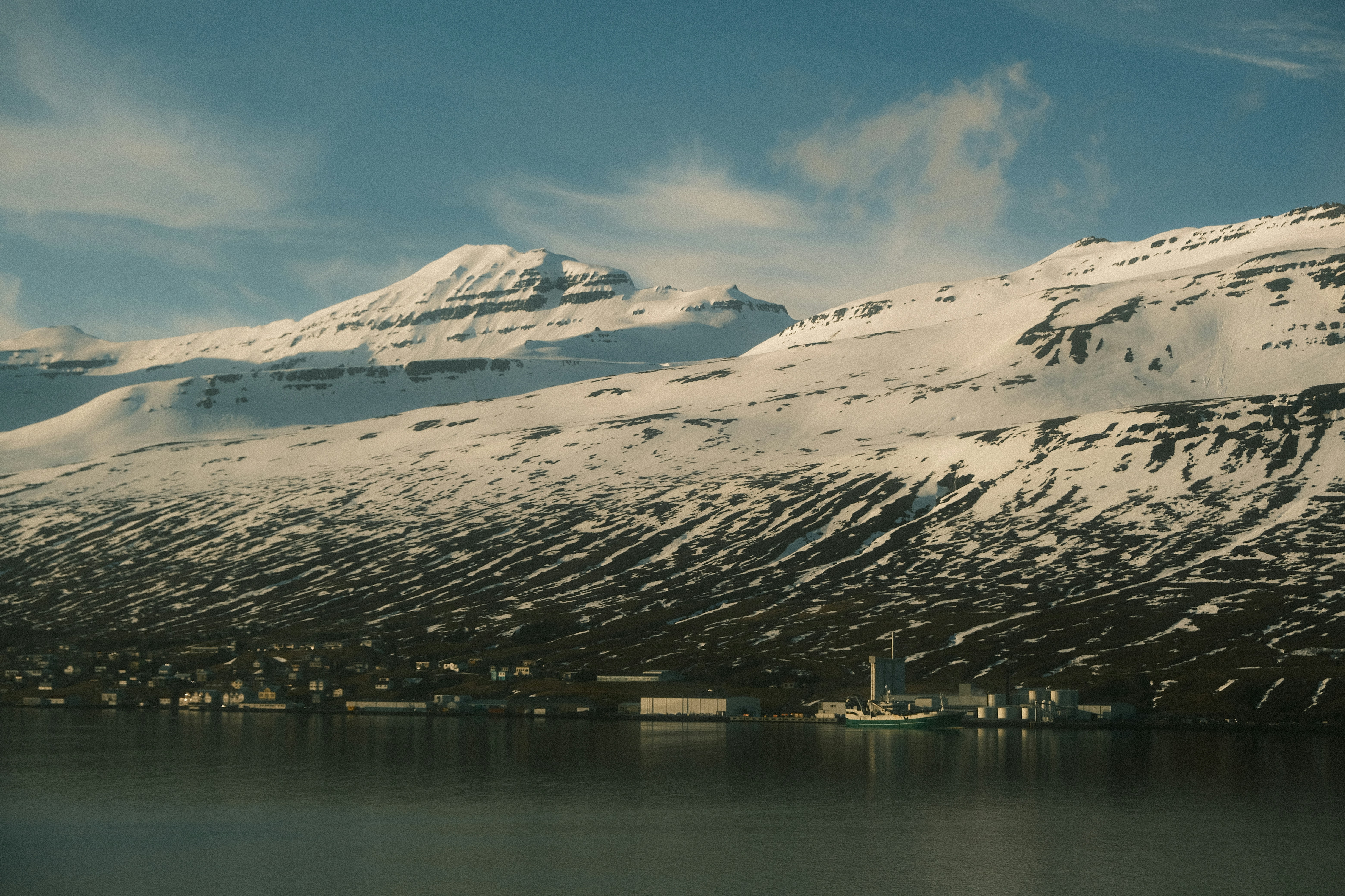 Snowbound Fjord: A Quiet Coastal Spine under a Wide Sky