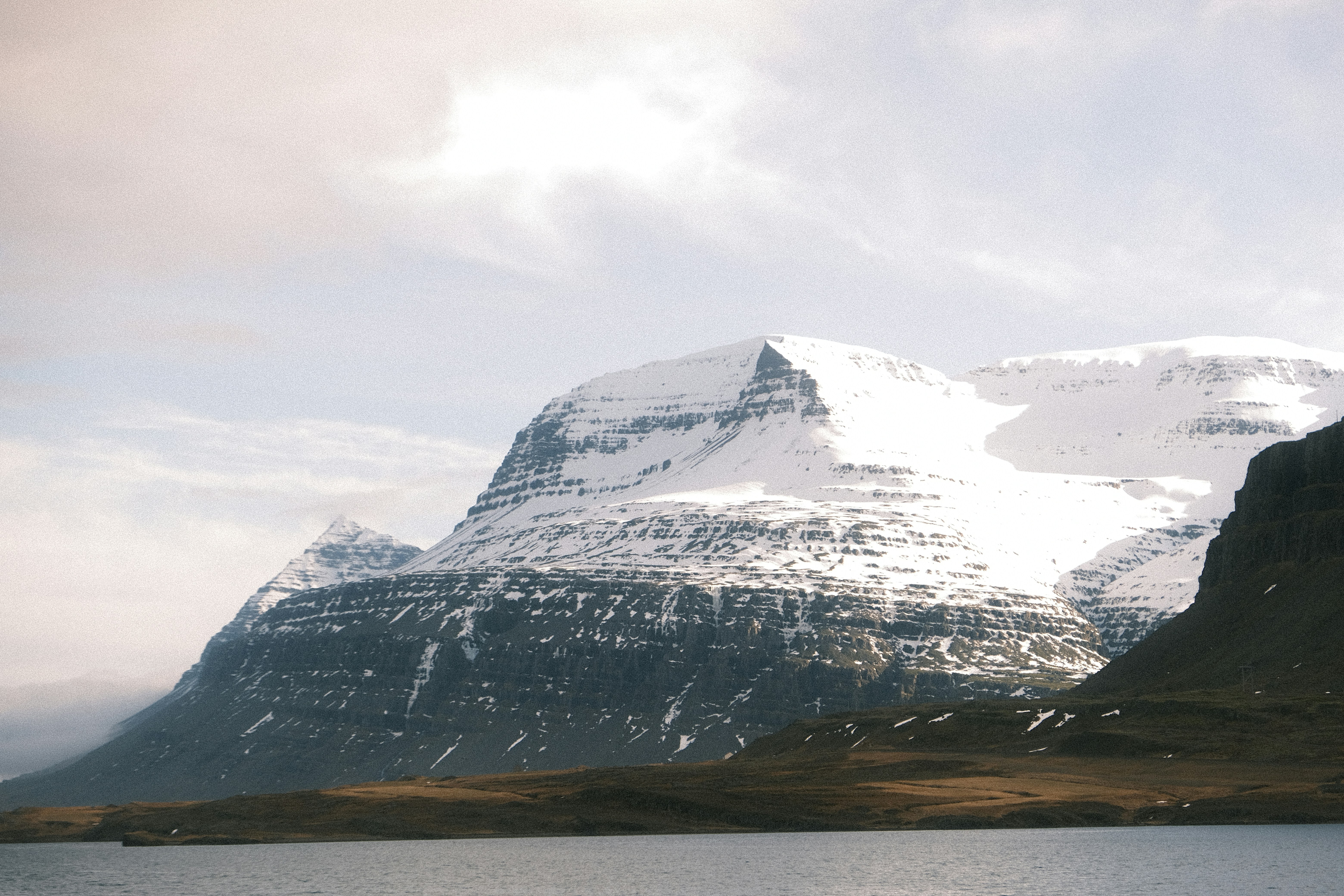 Snowcapped Ridge Meeting the Icelandic Shore