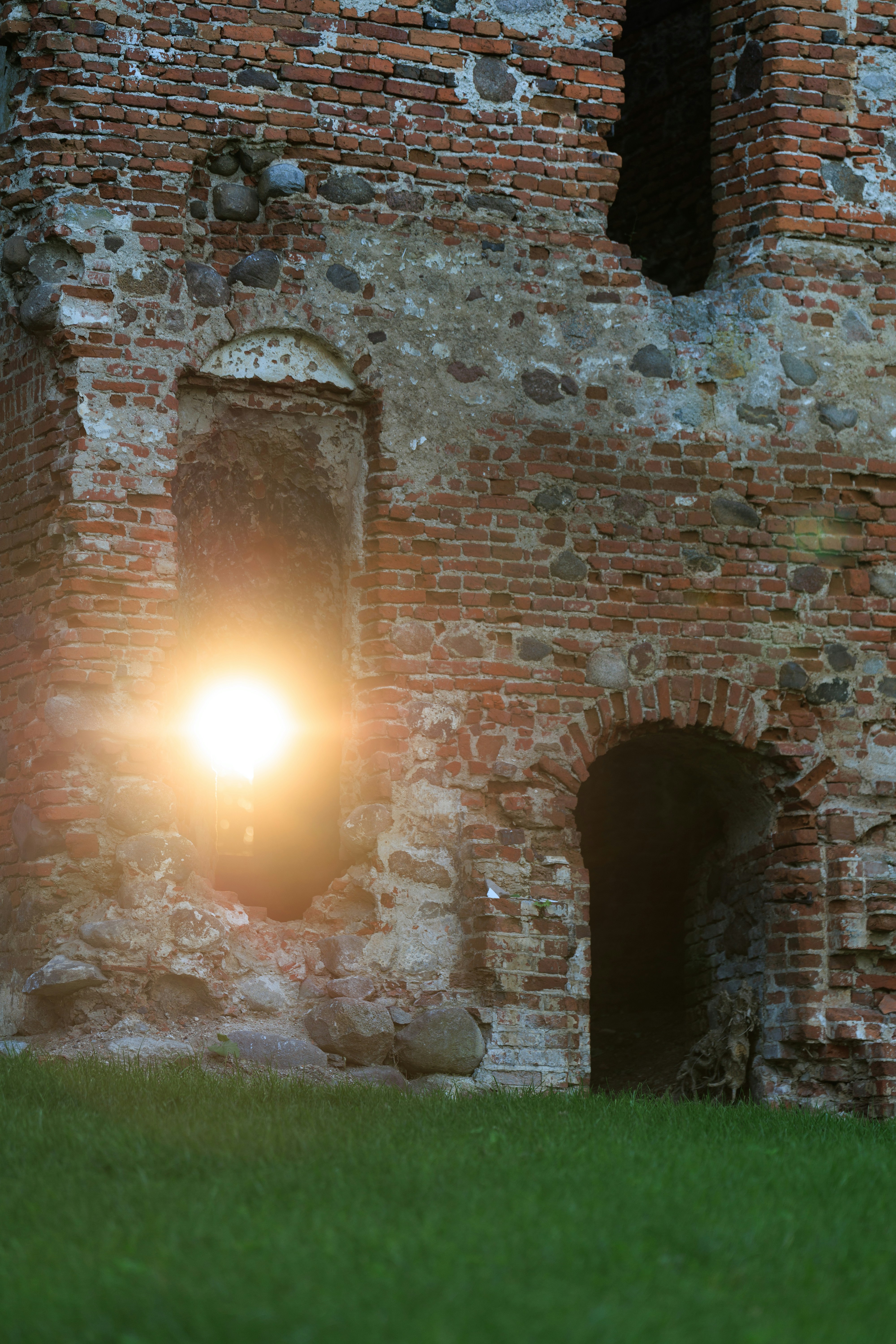 Ruins at Dawn: Ember of Light Through Old Brickwork
