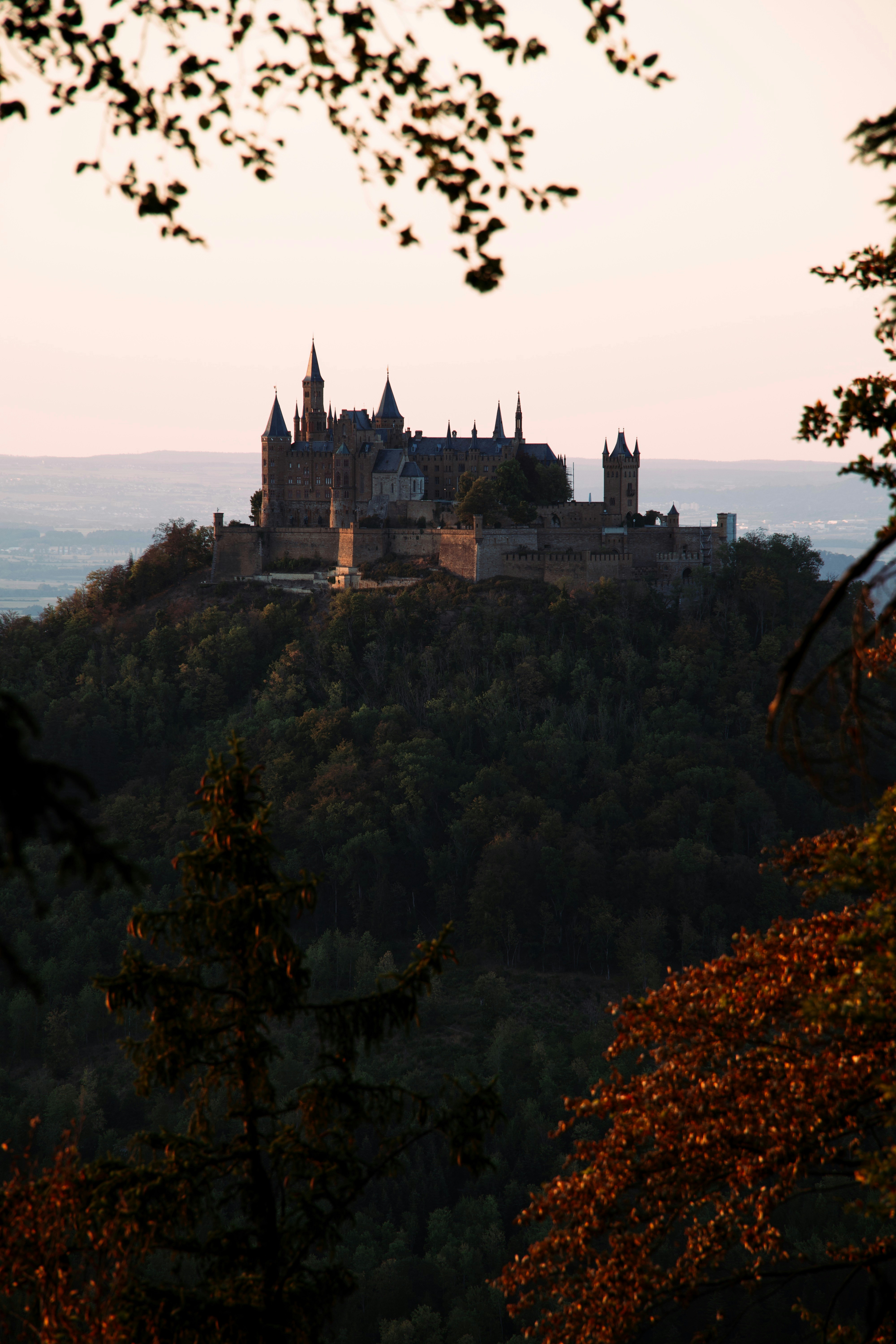 Horizon Fortress: A Castle Crowned on a Hill at Sunset