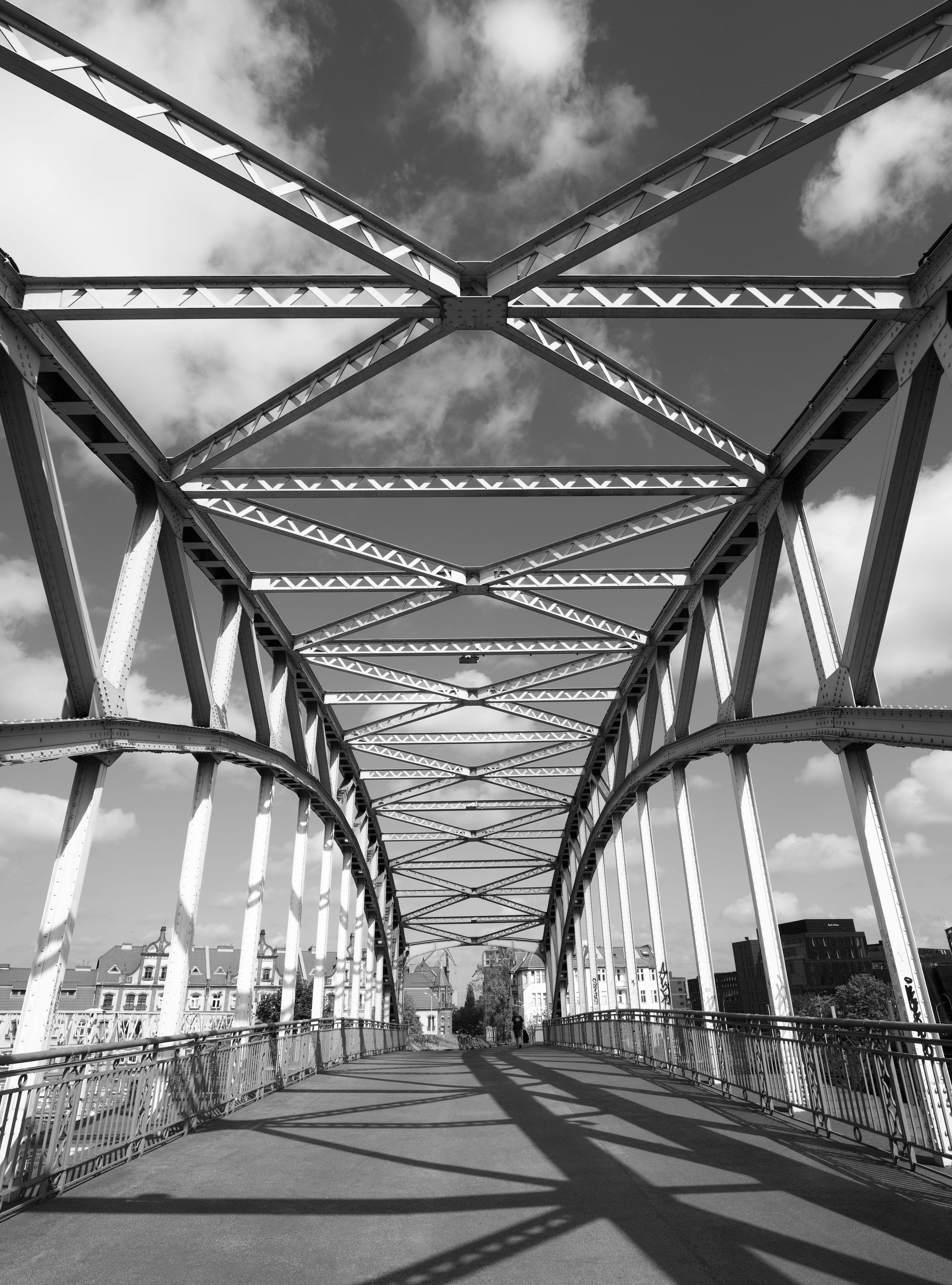 Crosshatched Skyward: A Steel Bridge Reaches for the City