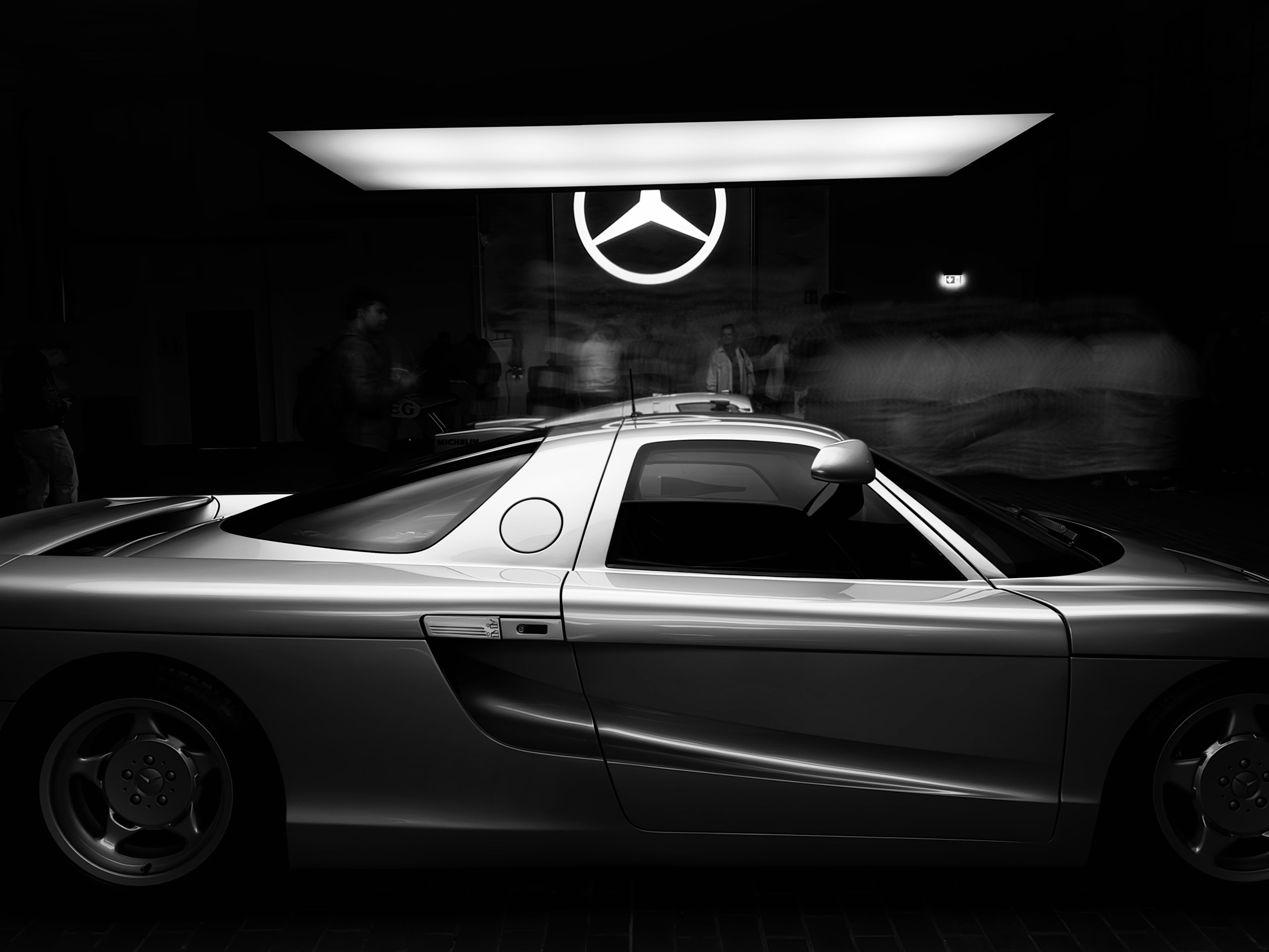Midnight Pulse: A Mercedes silver coupe under showroom glow