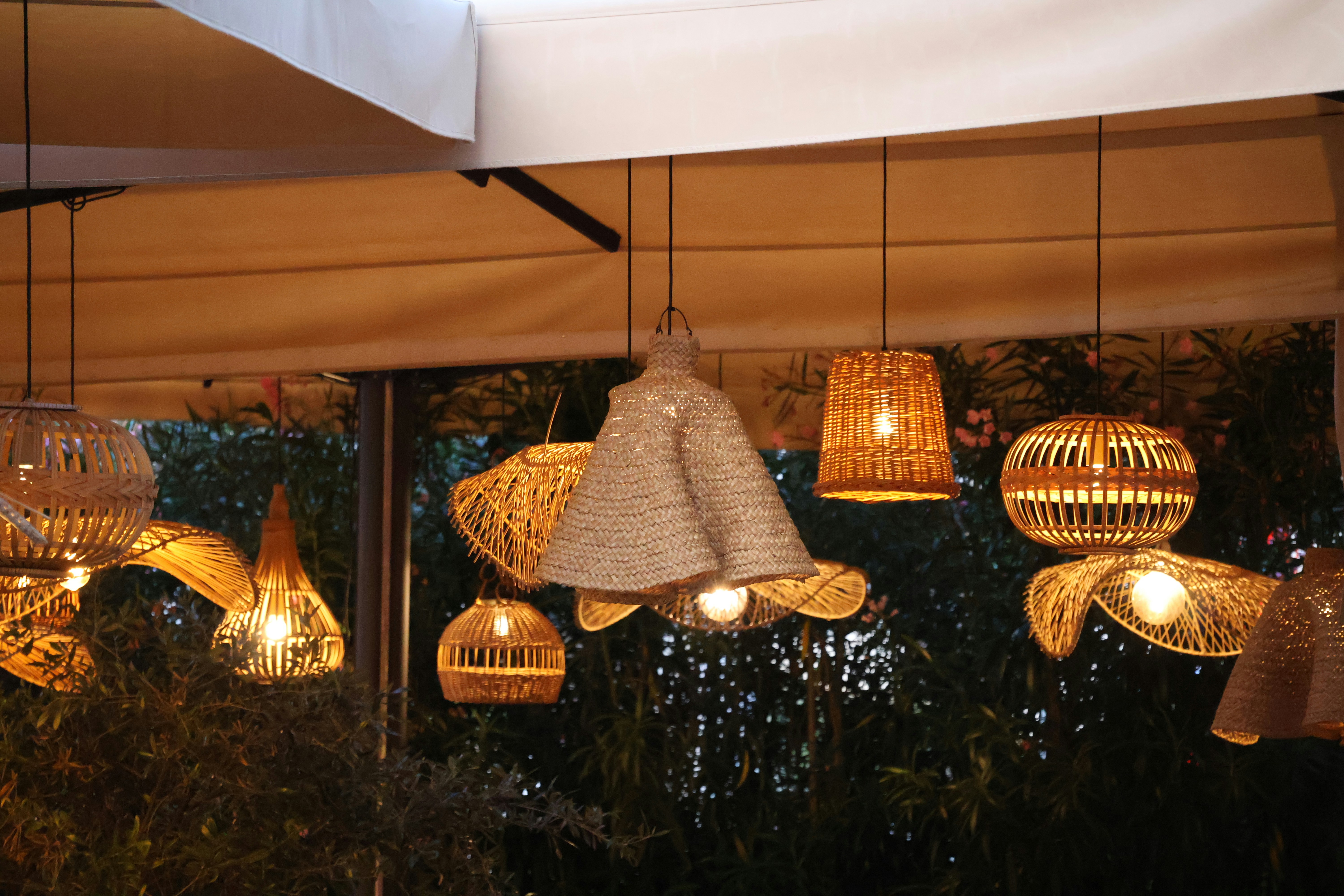 Lanterns in a warm dusk: woven glow over a shaded patio